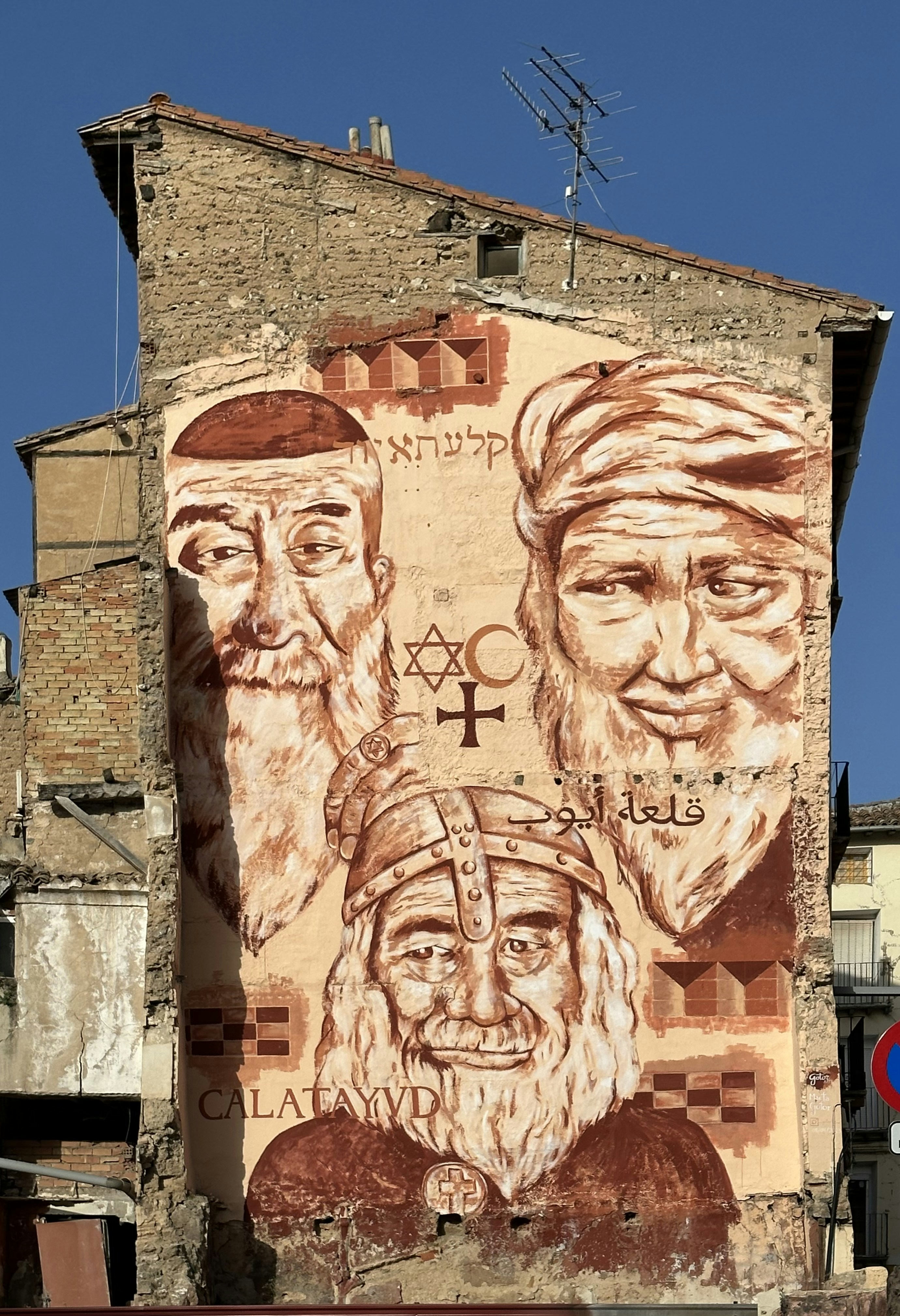 Faces of Faith: A Triptych Mural on Weathered Brick