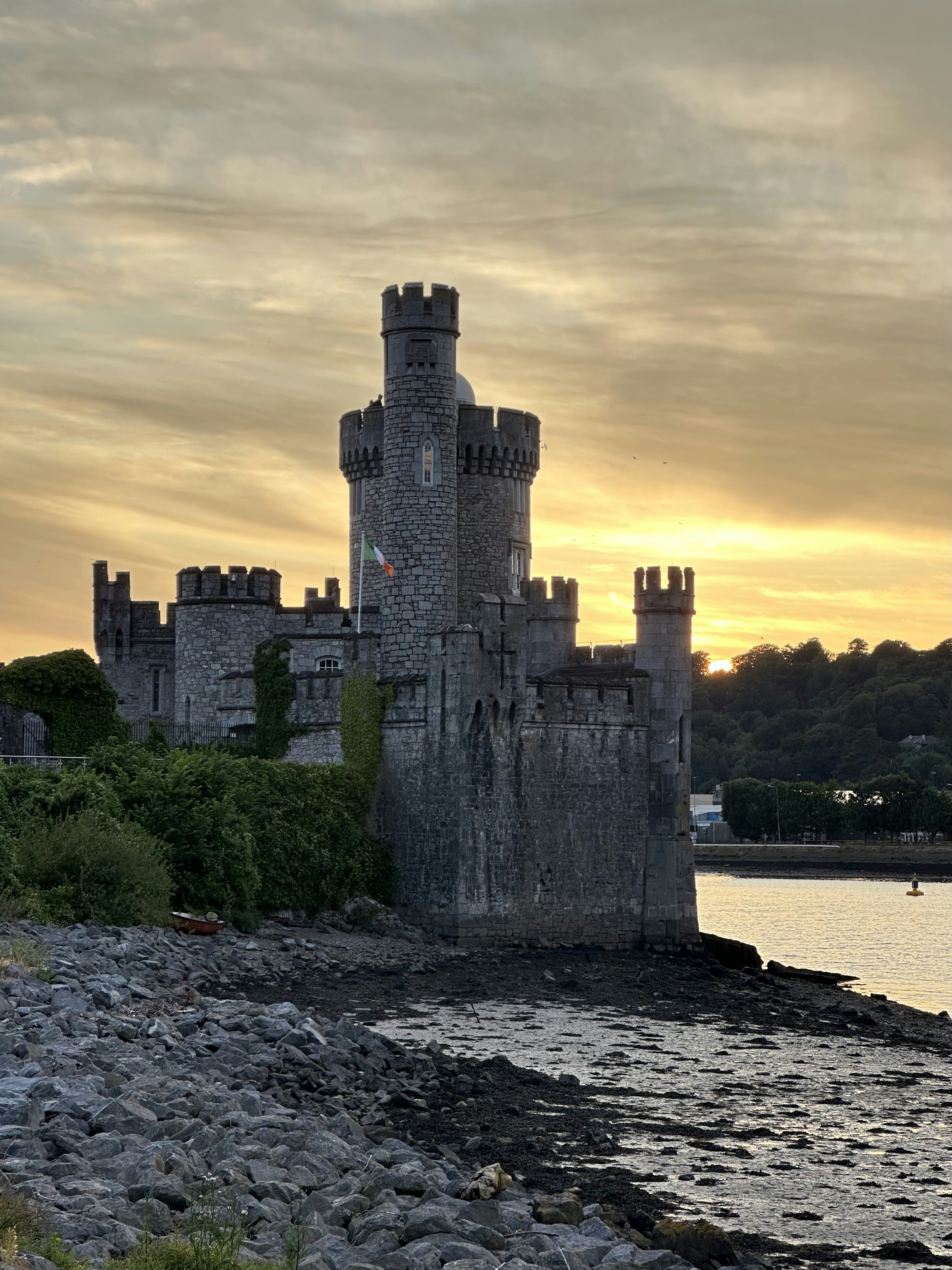 Sunset over the castellated shoreline: a medieval fortress by the water