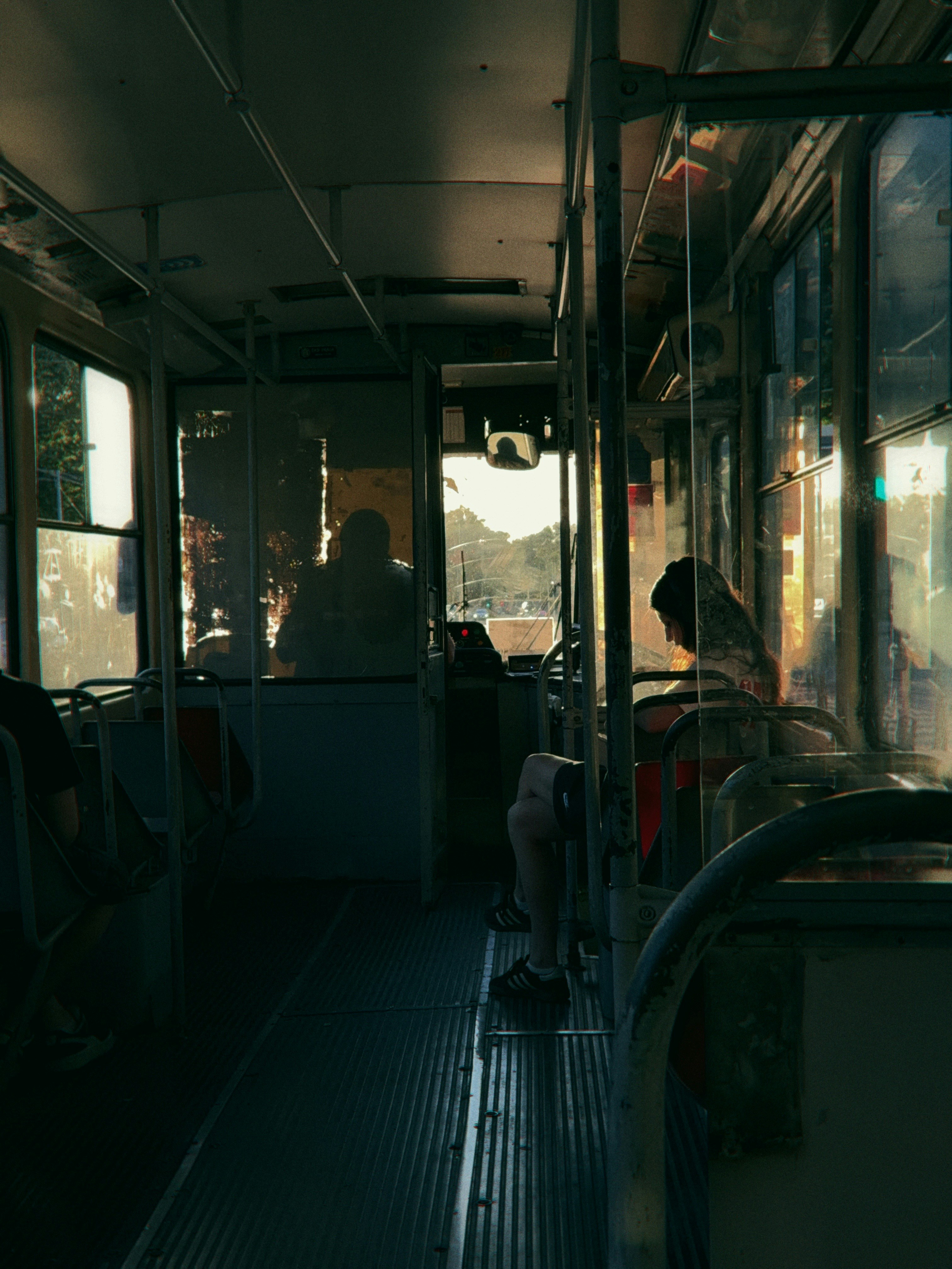 Quiet Rider in the Bus Kiosk of Dusk