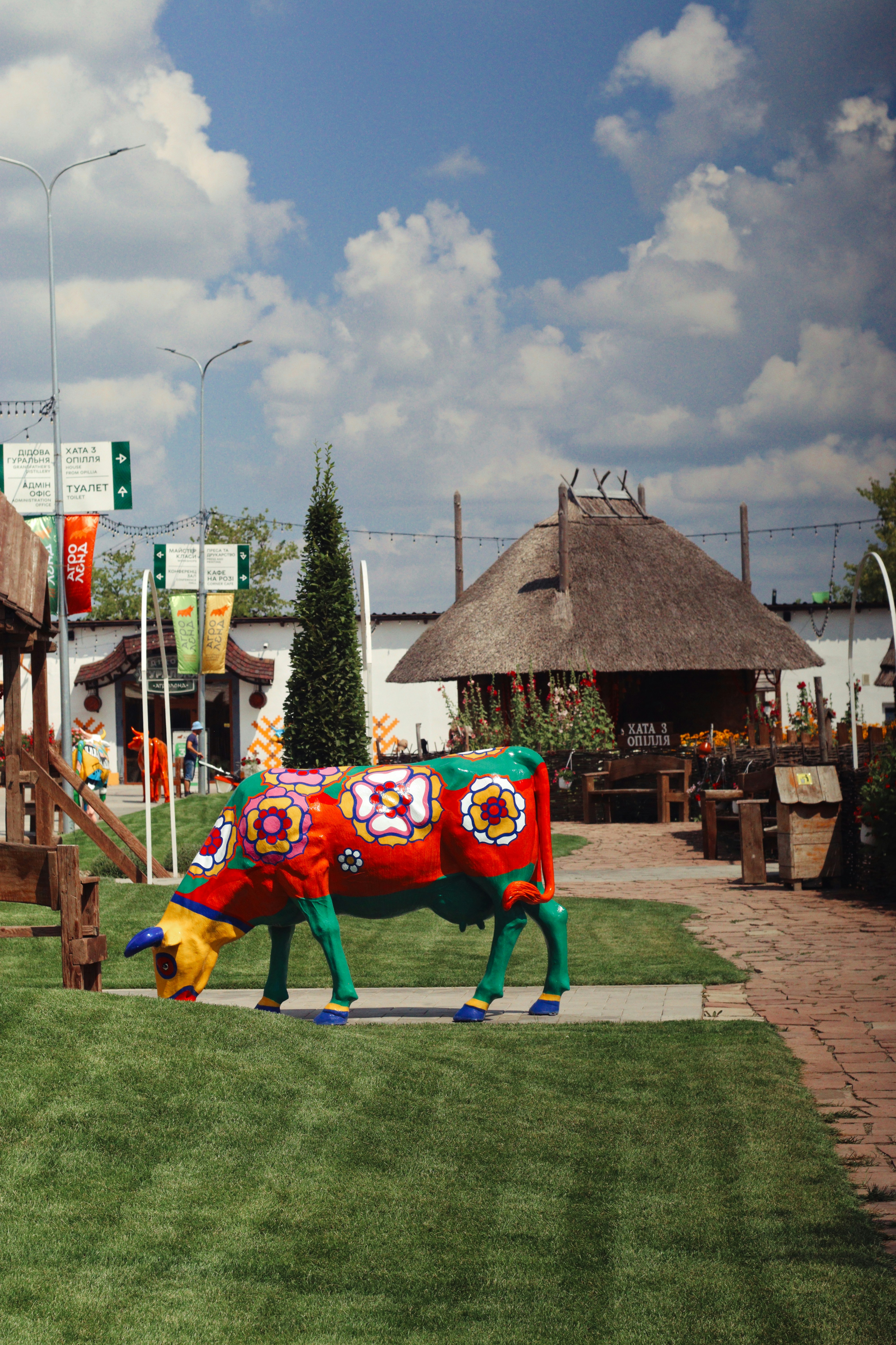 Colorful Painted Cow Amid a Rustic Plaza
