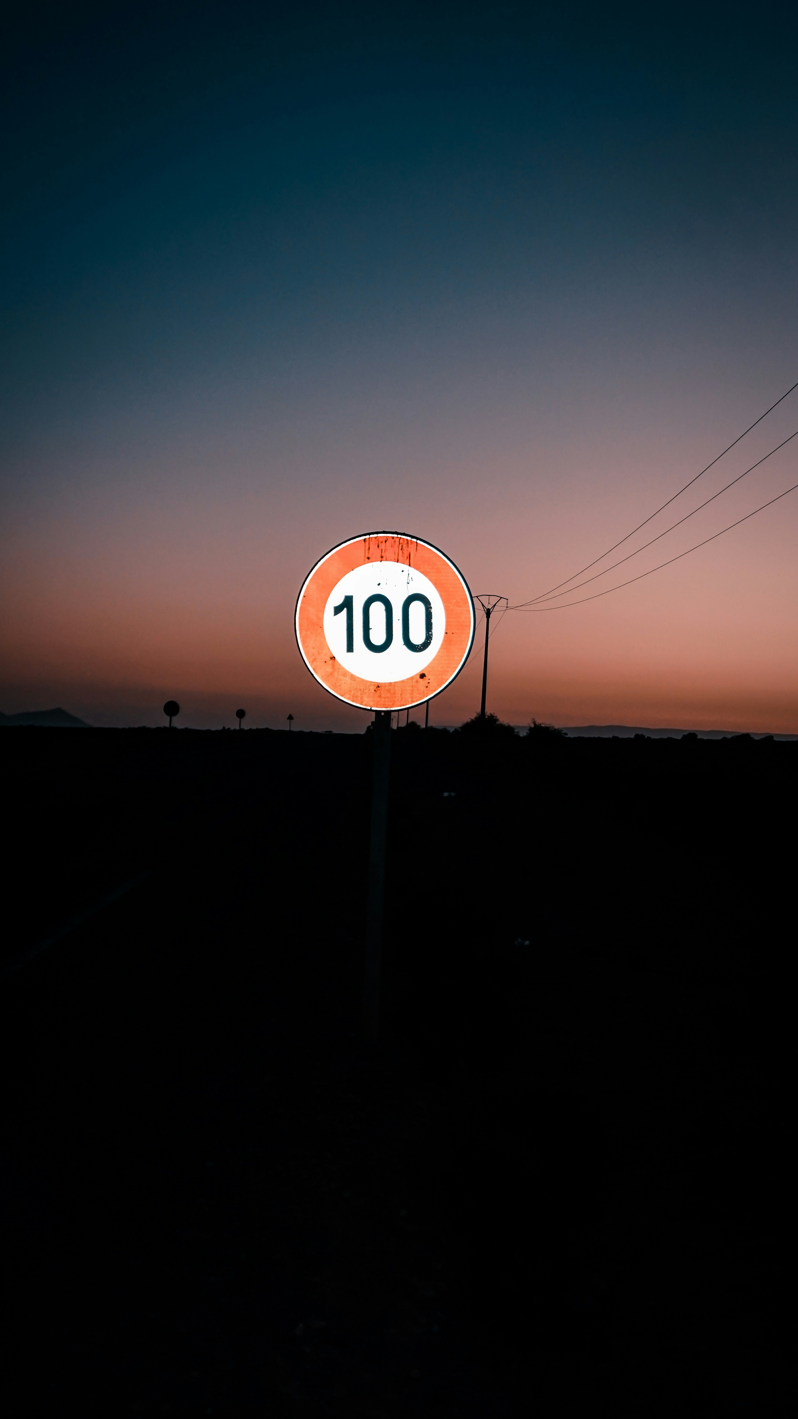 Borderline Silence: A Sunset Pause with a Weathered Speed Sign