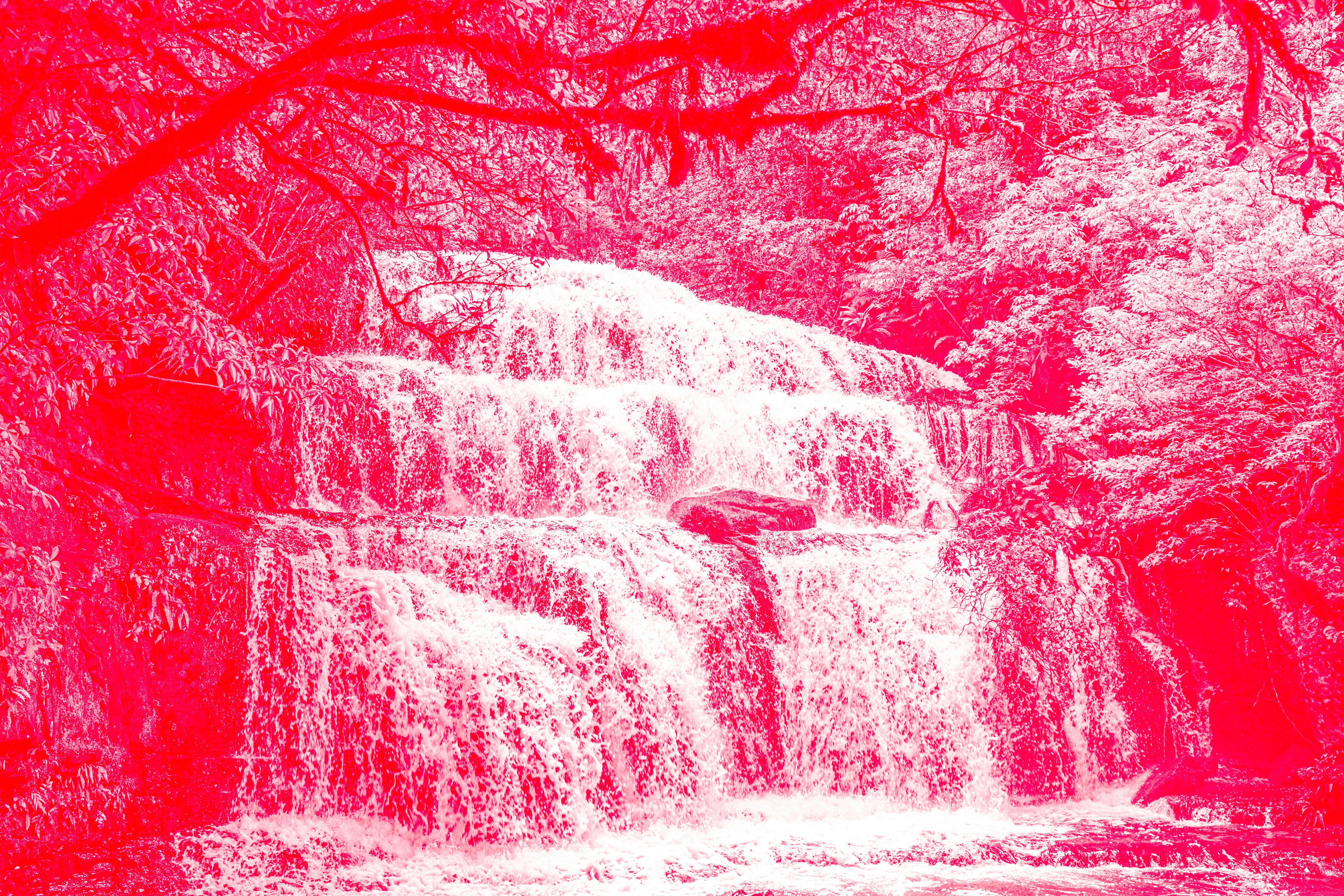 Red-veiled Cascade: A Waterfall Scene Forged in Monochrome Heat