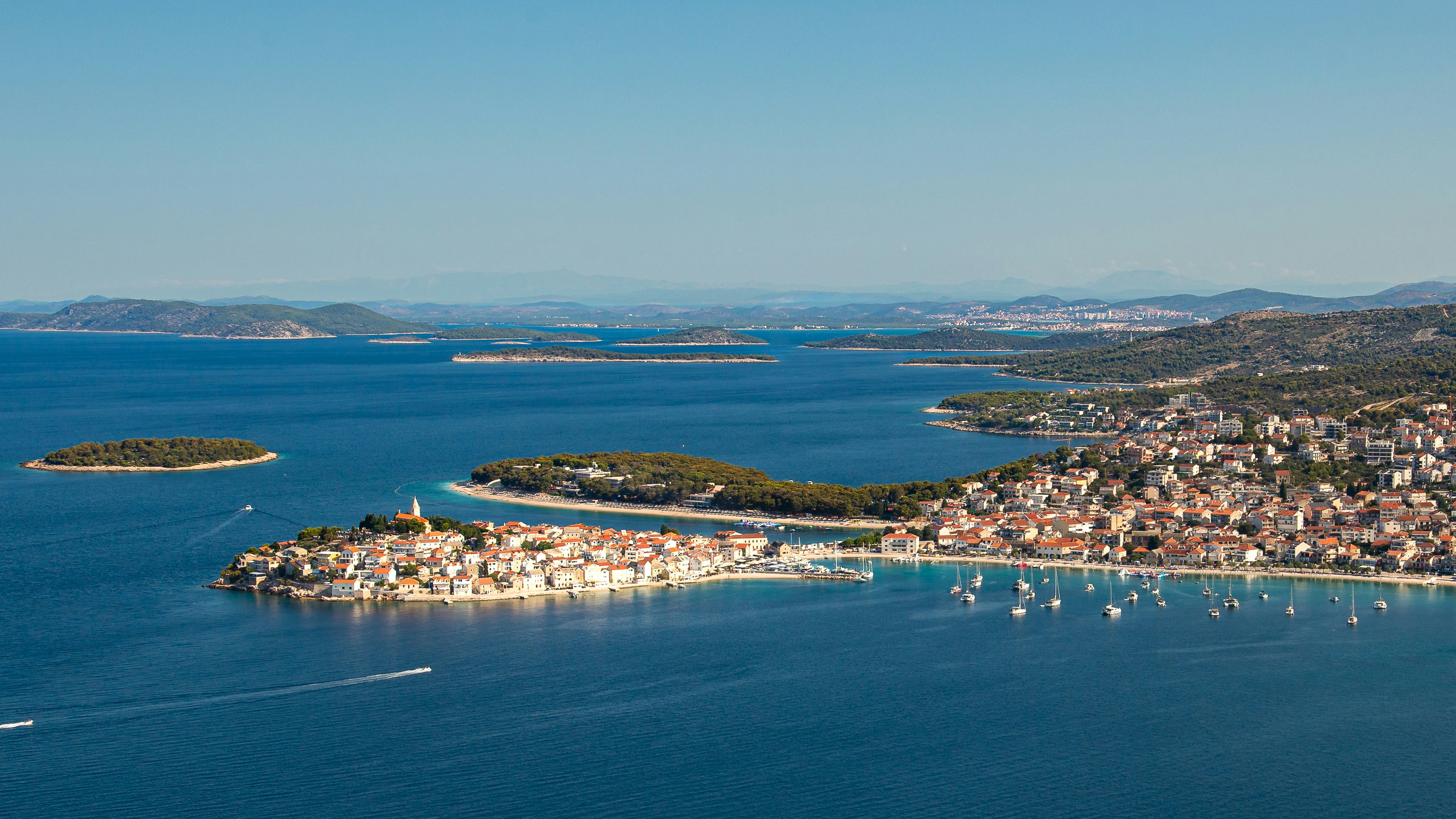 Harbored Charm: Aerial View of a Coastal Town Fringed by Boats