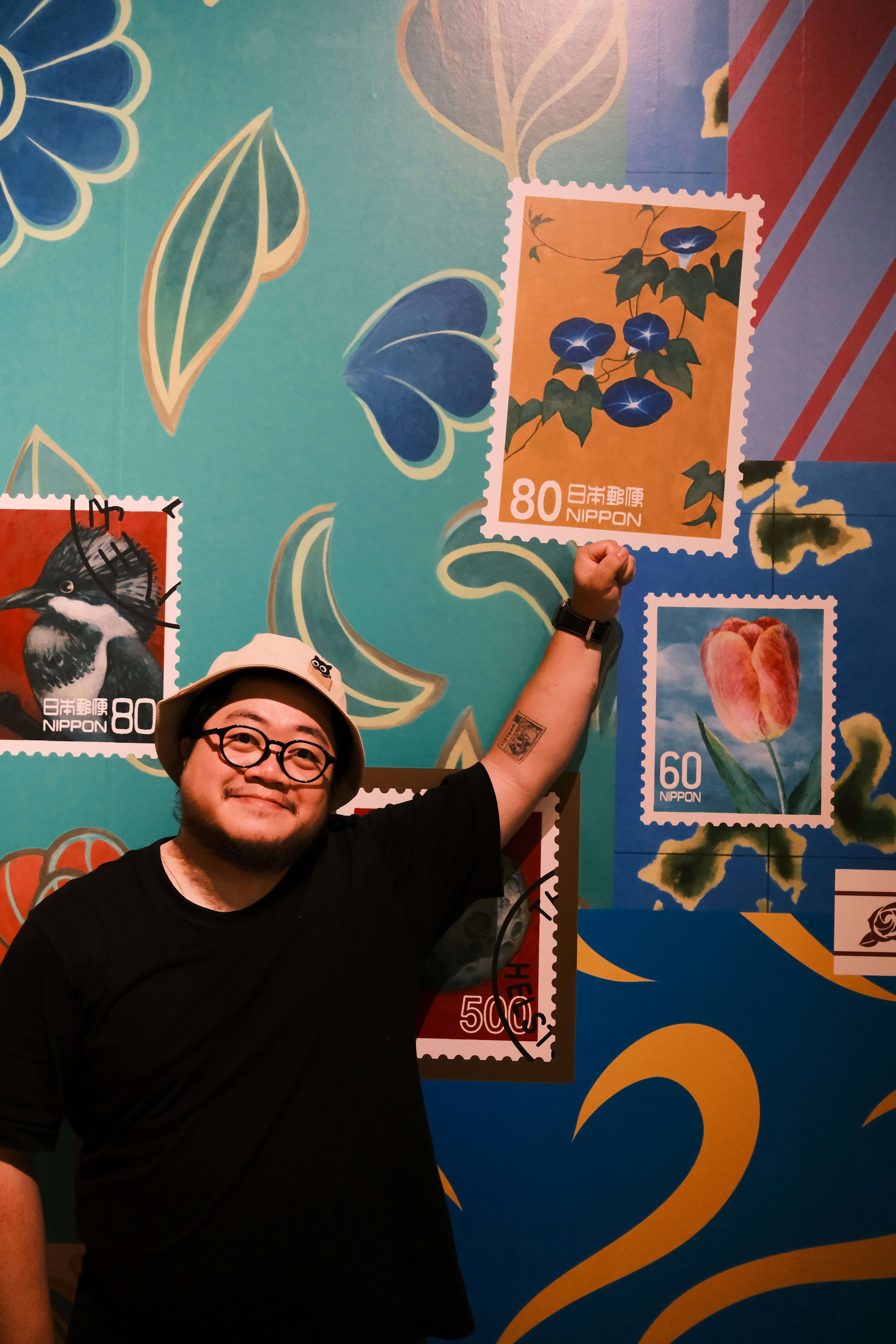 Thumbs Up Under Giant Stamp Wall