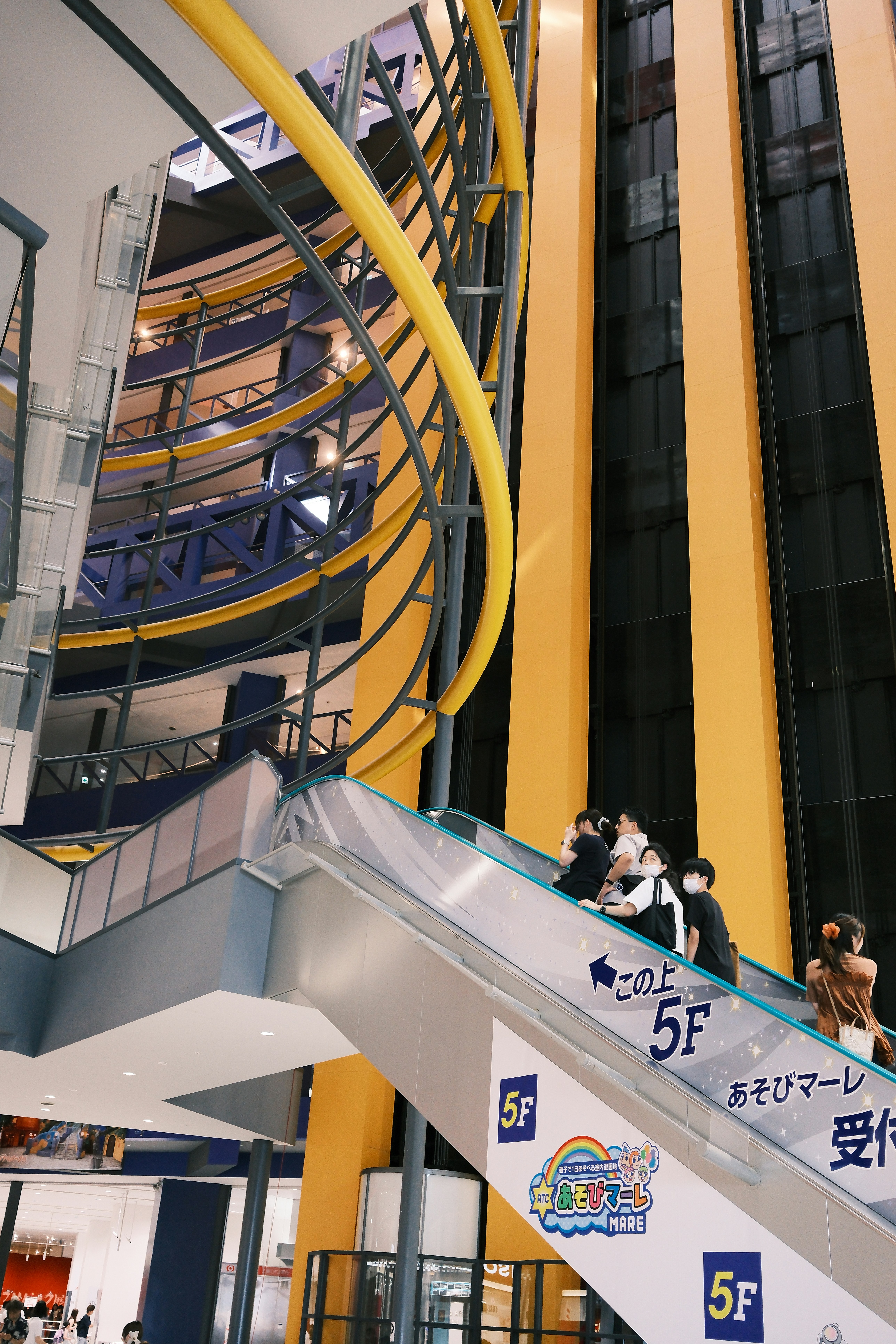 Escalator to Colorful Spirals: A Modern Atrium Moment