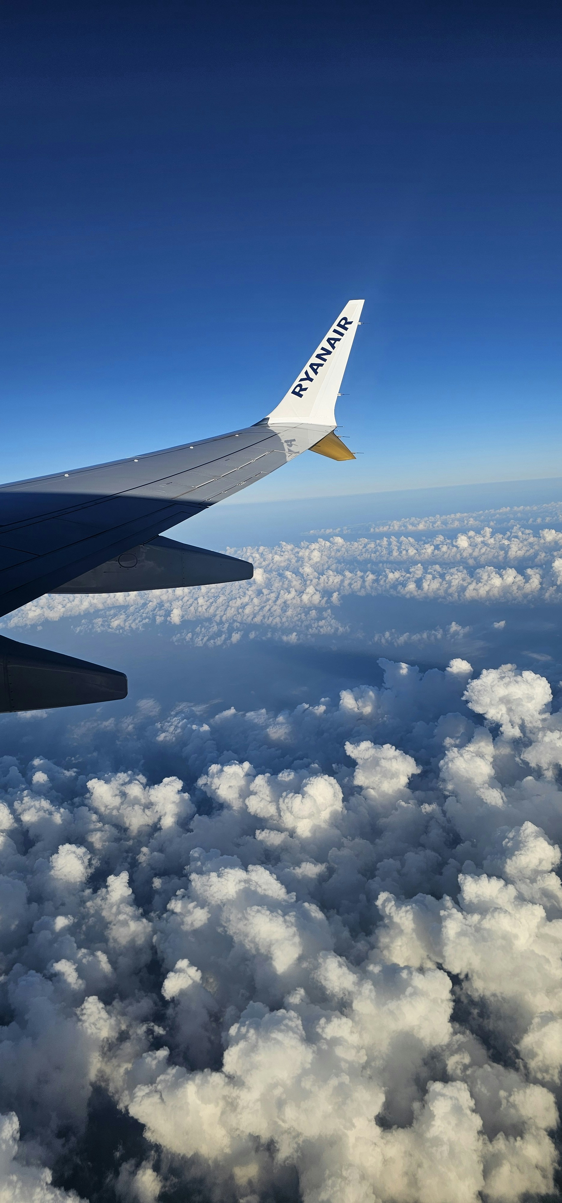 Ryanair Wing Over a Sea of Clouds: A Skybound Window