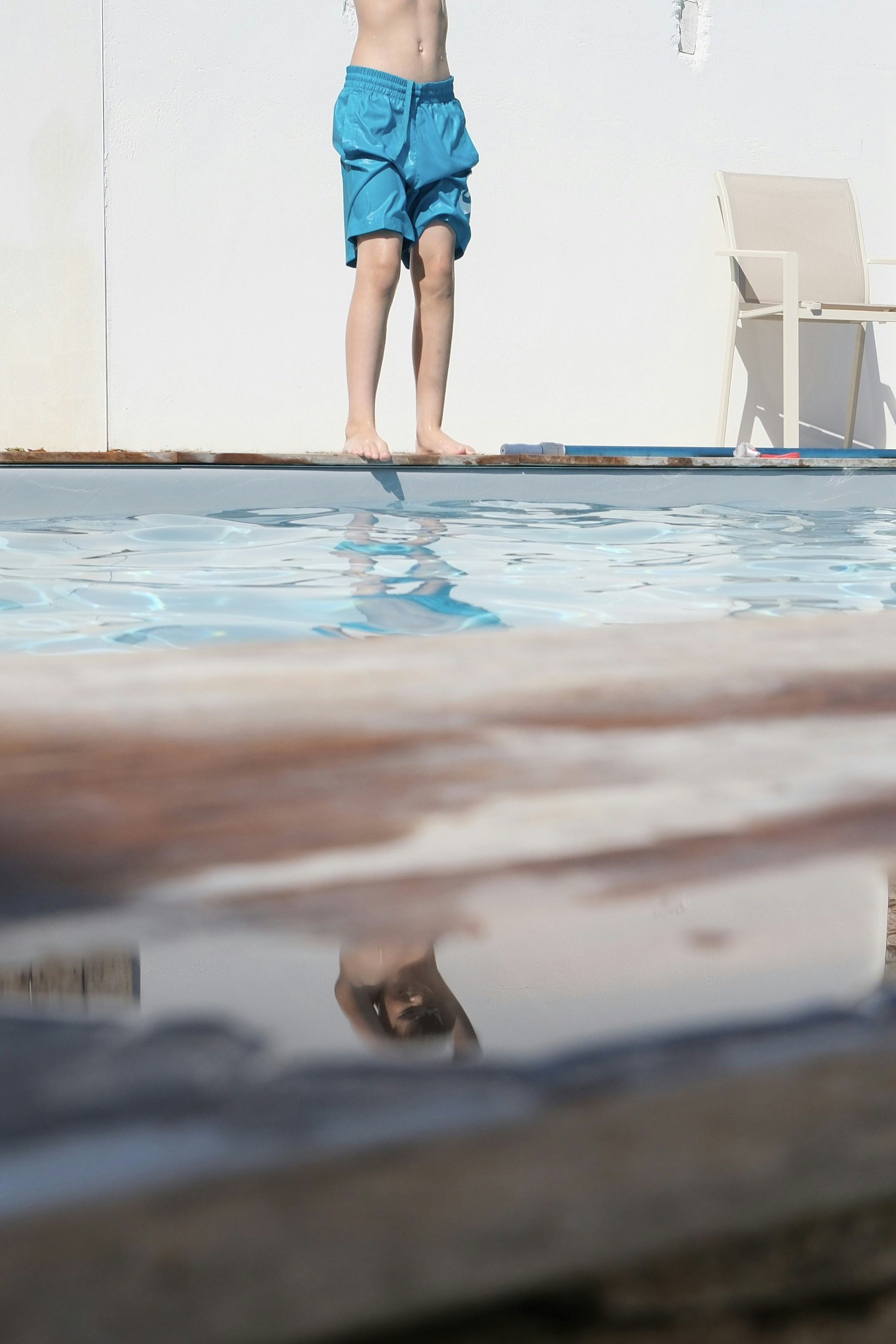Summertime Leap: A Poolside Moment Above the Waterline