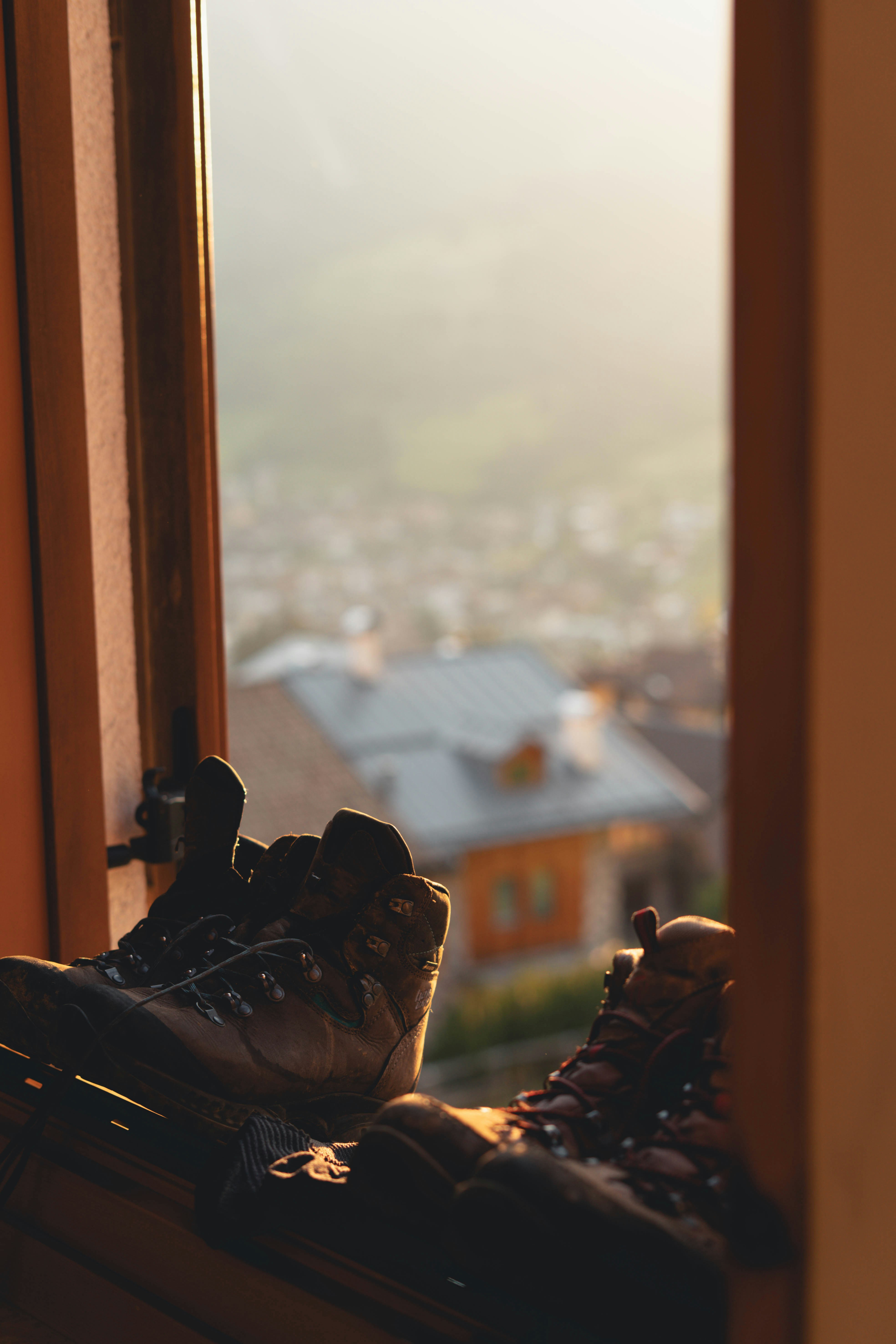 Boots by the Window: Quiet Pause on a Sunset Stairwell