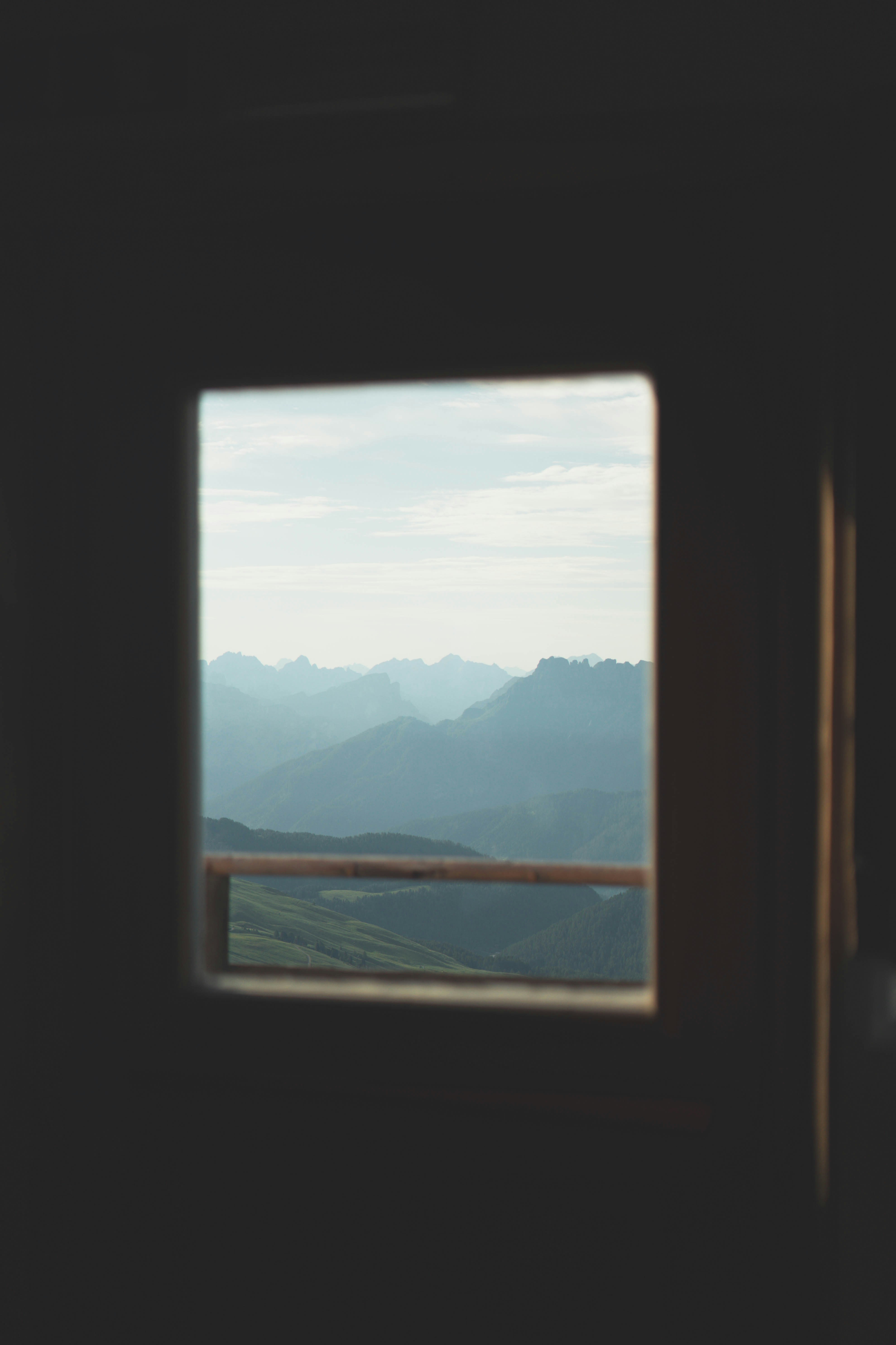 Through a Quiet Window: Mountain Ridges Unfold in Soft Light