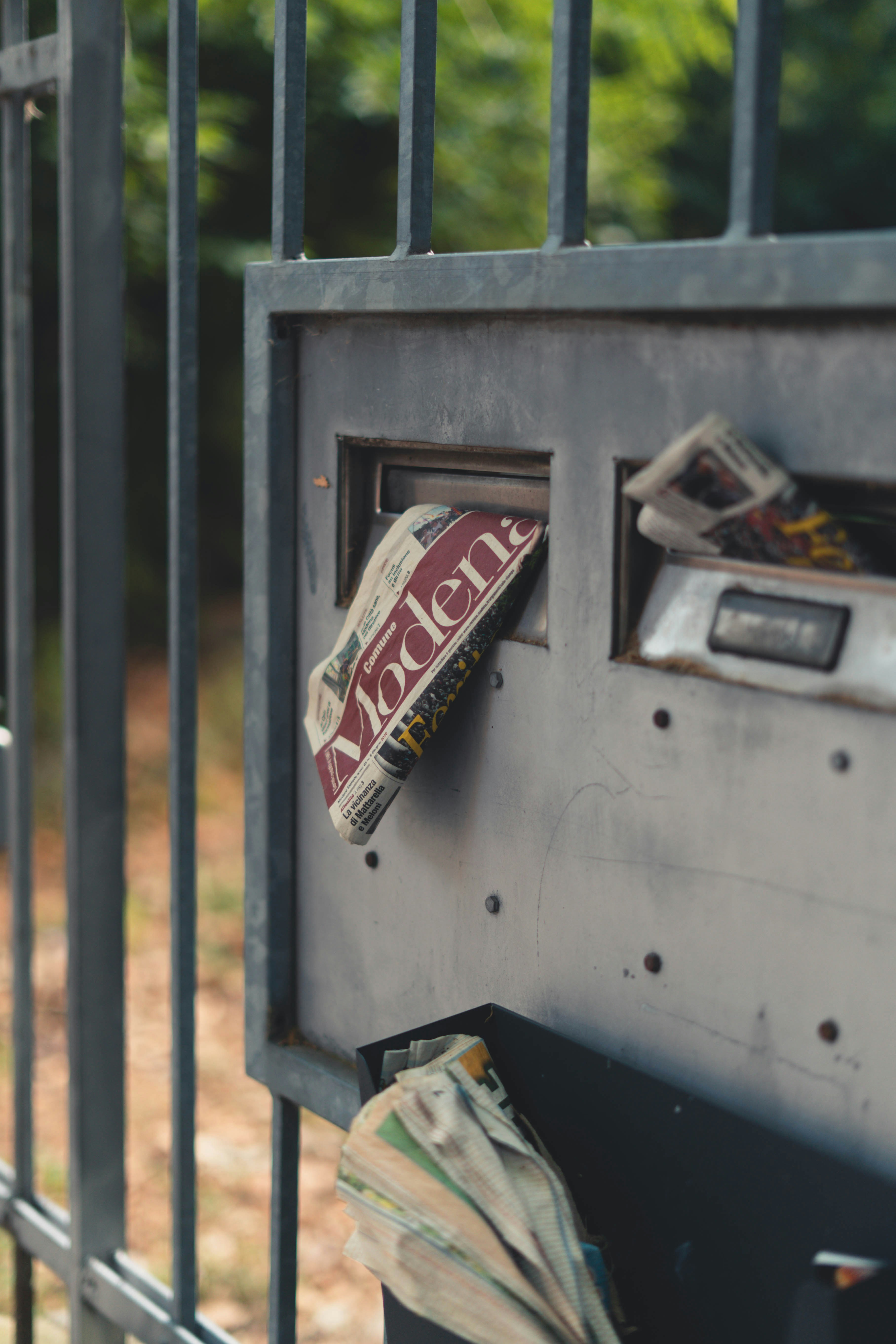 Newspaper in a Mailbox: Frayed Messages Through a Metal Gate