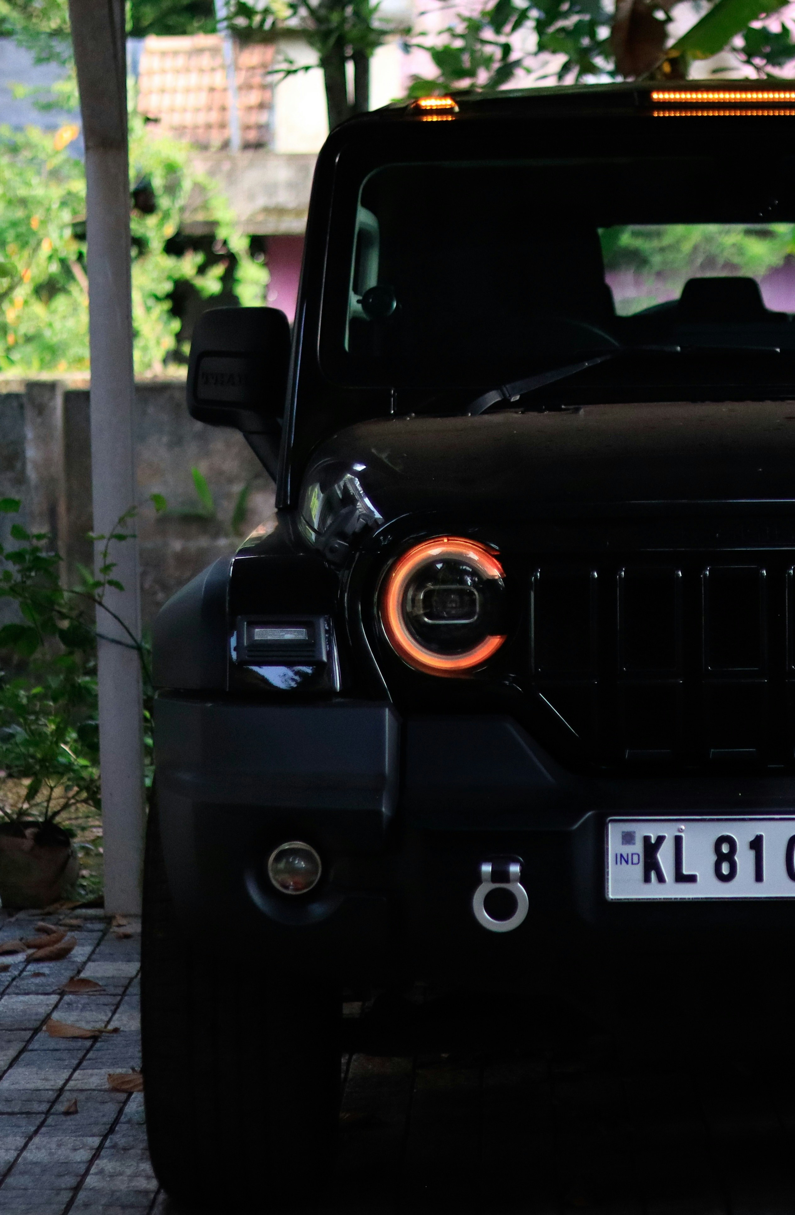 The Night-Glowing Grille: A Dark Jeep with Neon Ring Headlamp