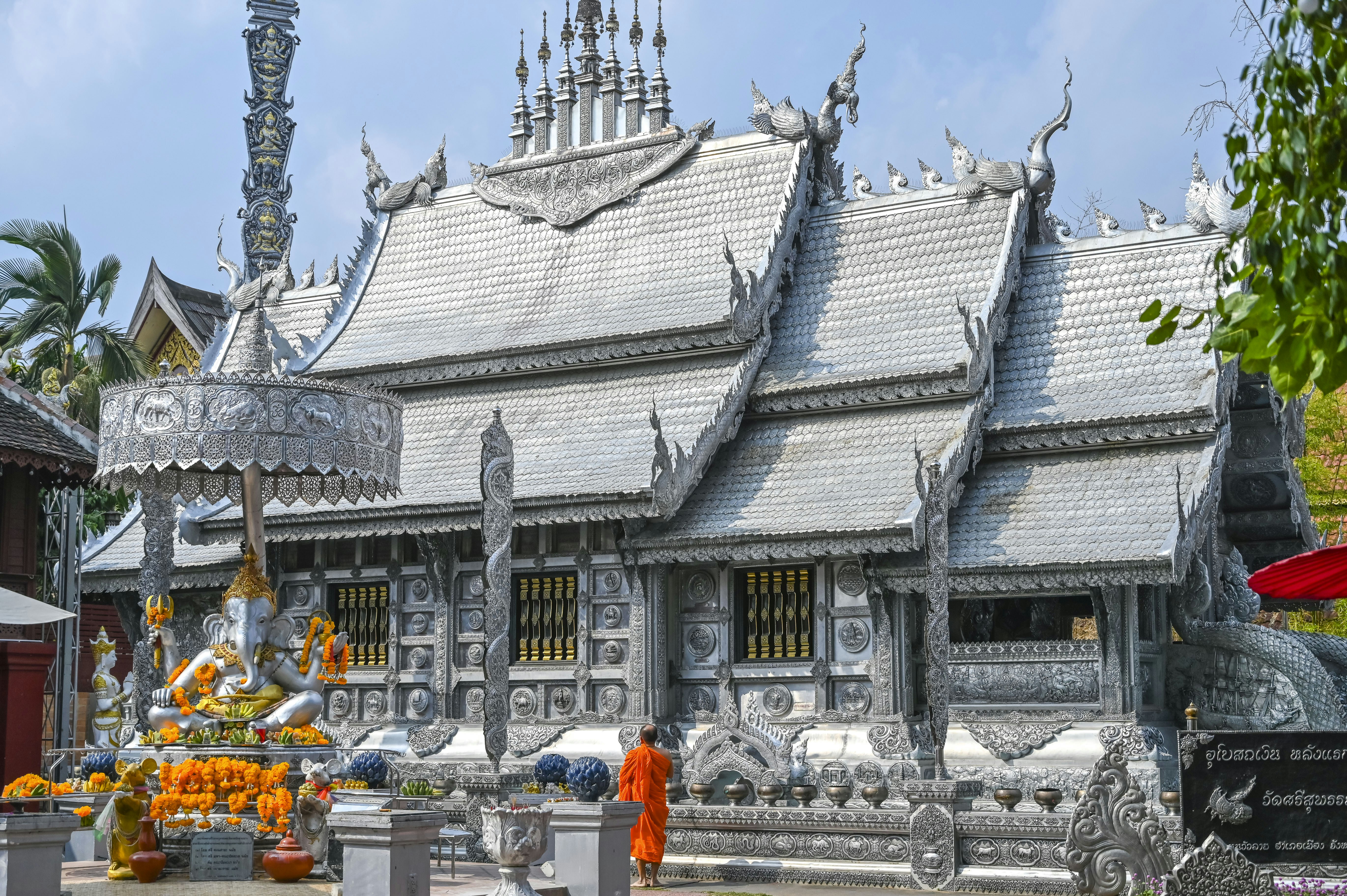 Stone Temple in Quiet Courtyard: Monks, Offerings, and Intricate Carvings