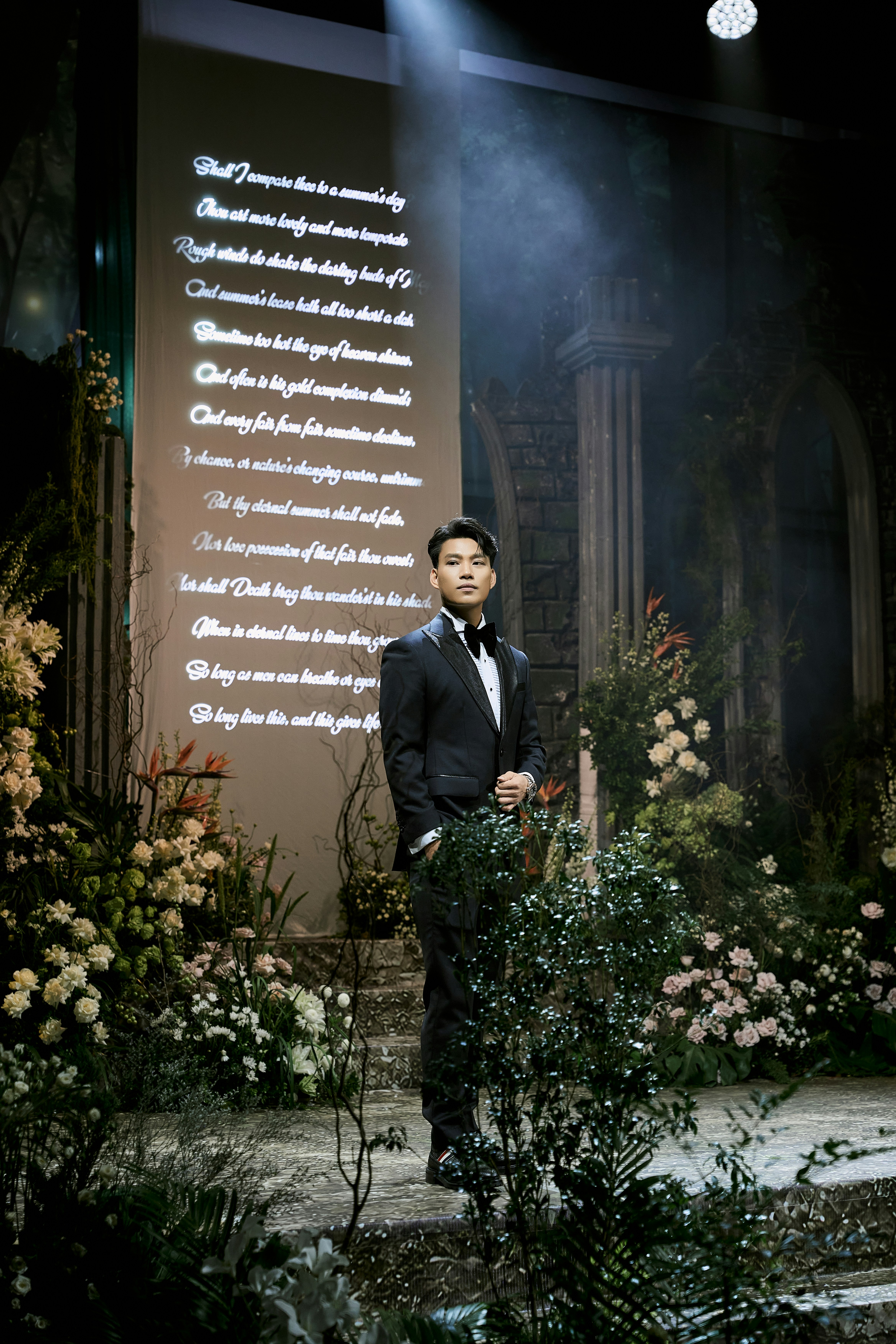 Groomed in Spotlight: A Dapper Moment Beneath Scripted Light