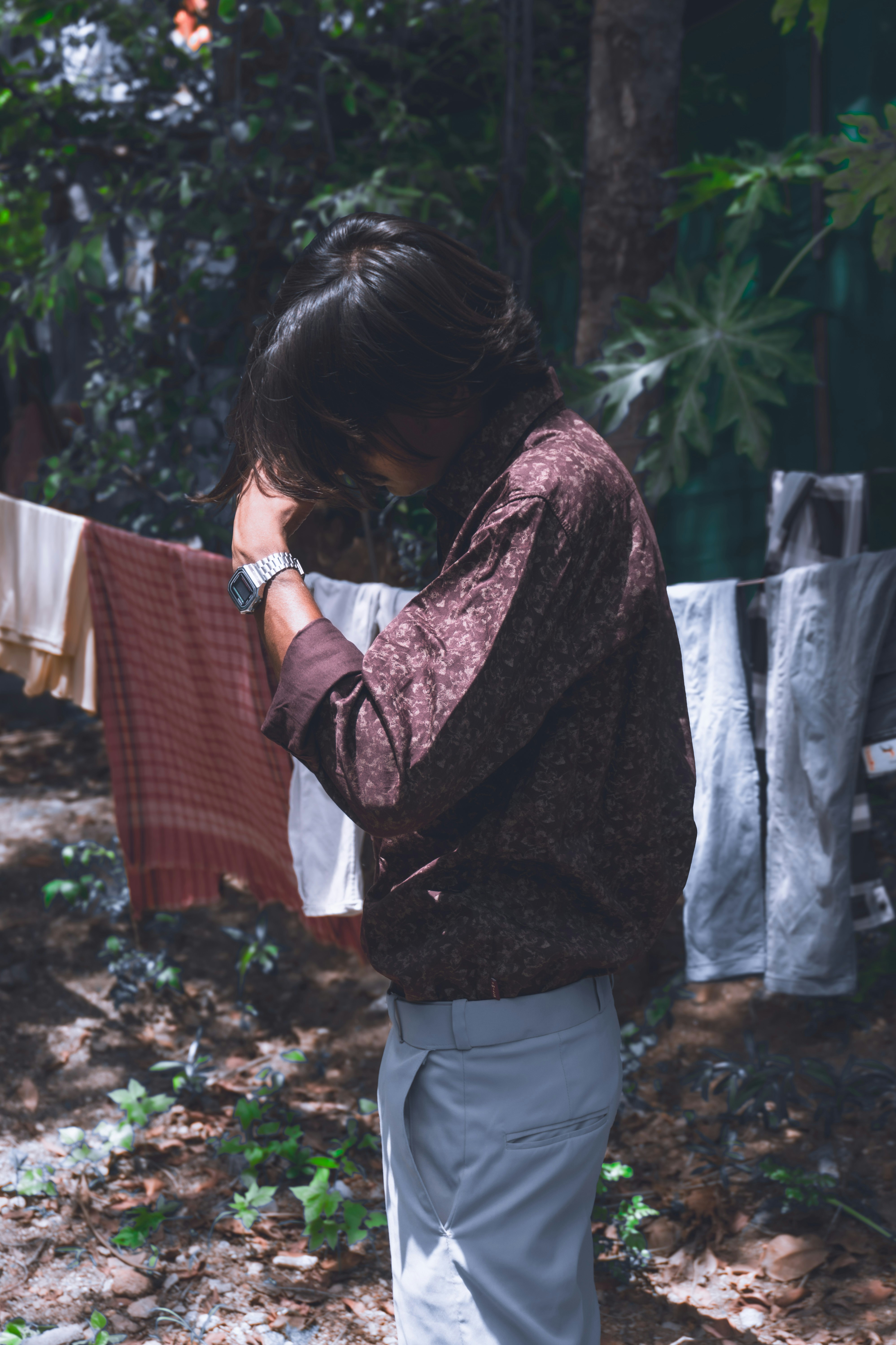 Portrait in the Laundry Line: A contemplative moment among clothes and greenery