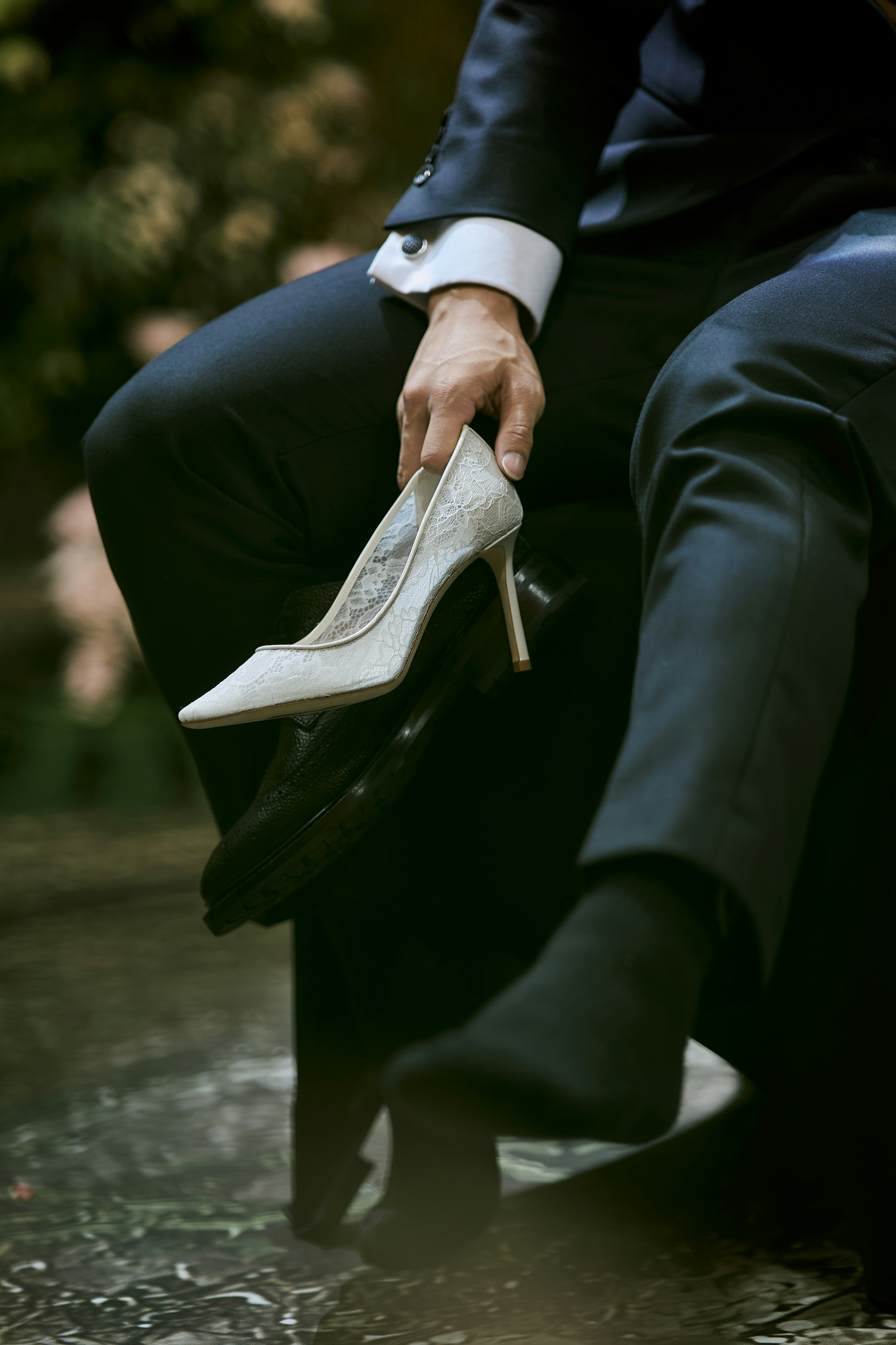 Bridegroom's Quiet Moment: A White Lace Heel and Gentle Grooming