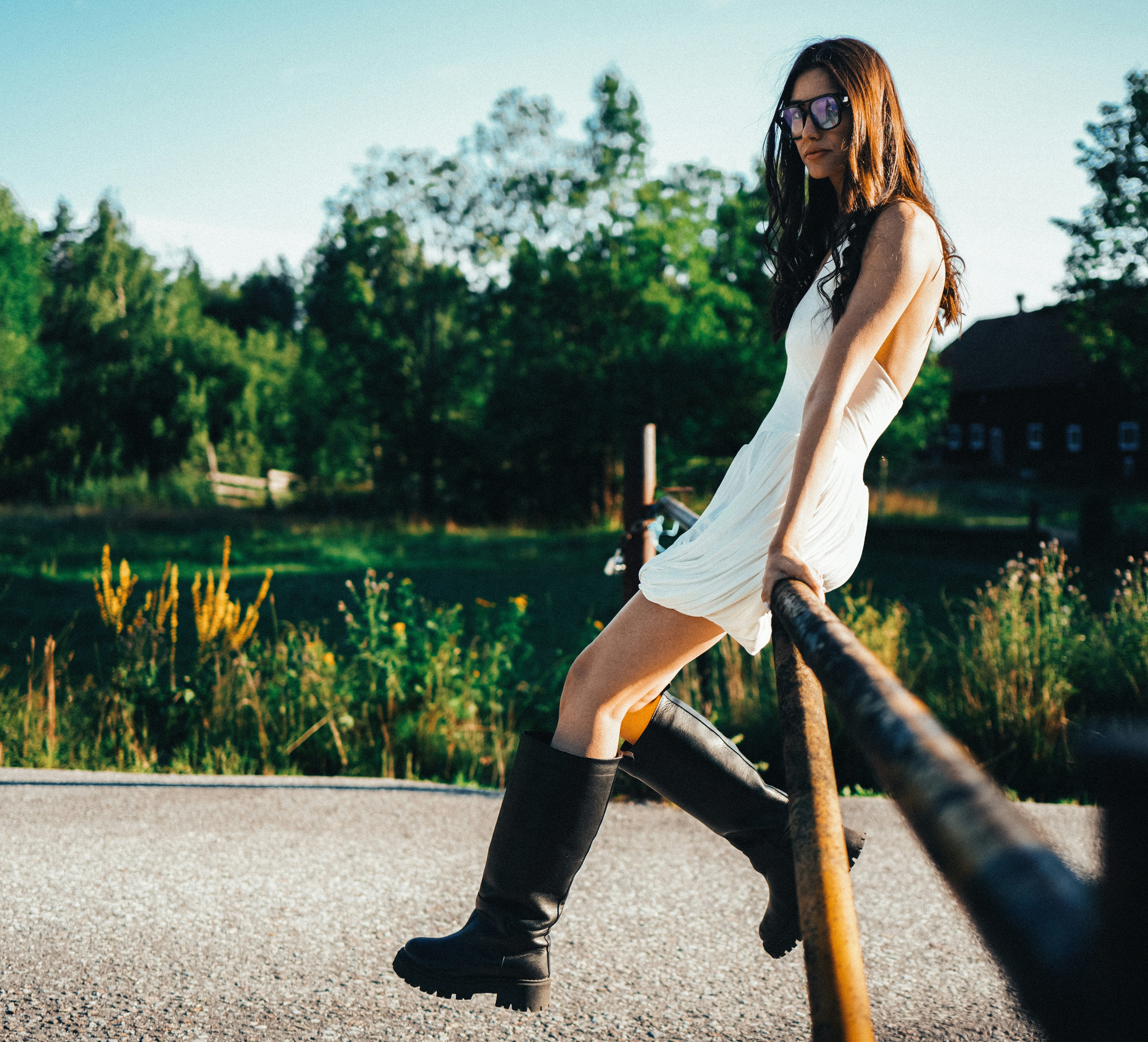 White-dress wanderer perched along a rustic railing