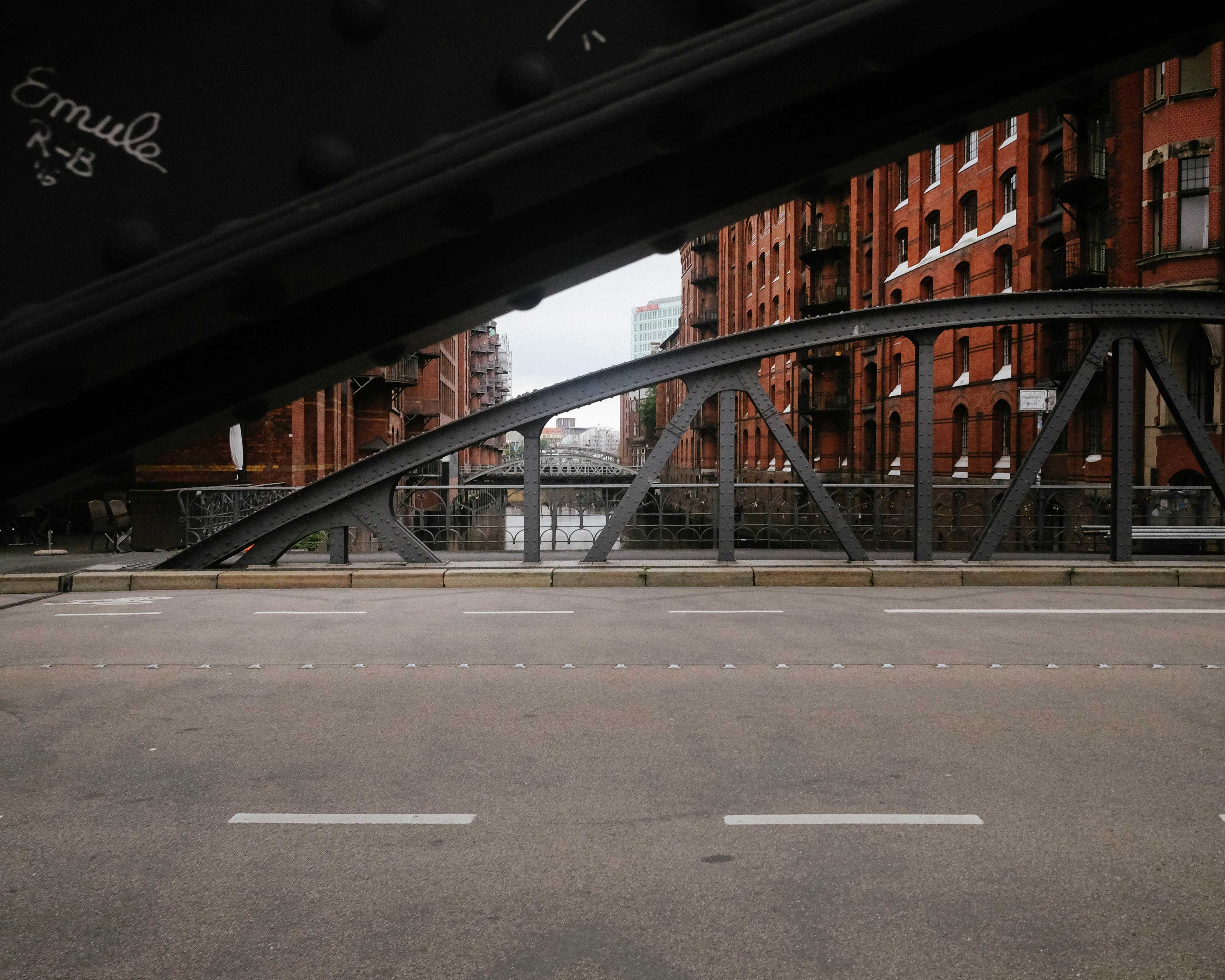 Under the Bridge: Urban Rust and Railings Framing a City Street