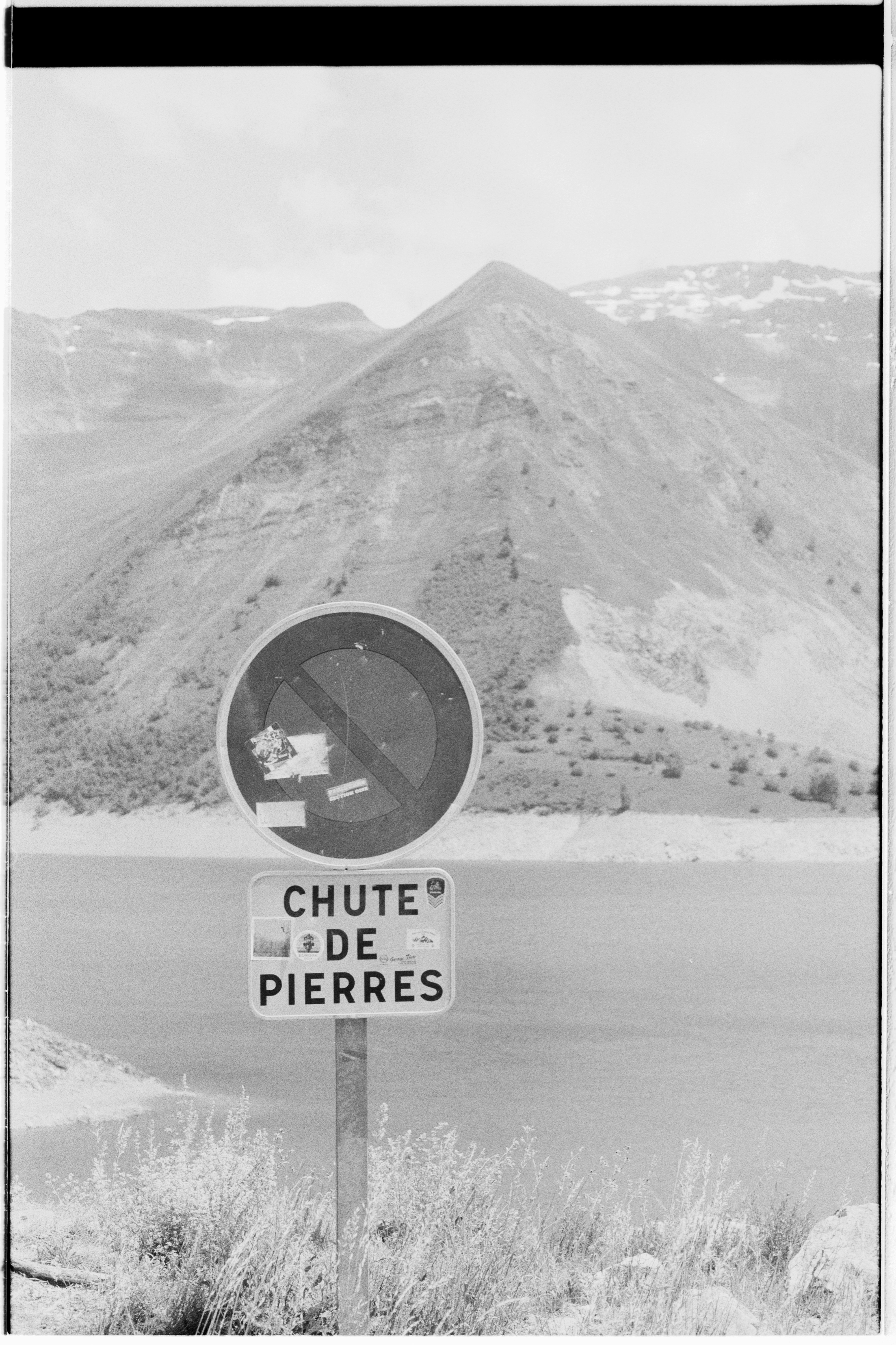 Signpost Halting the Horizon: Chute de Pierres with Alpine Backdrop