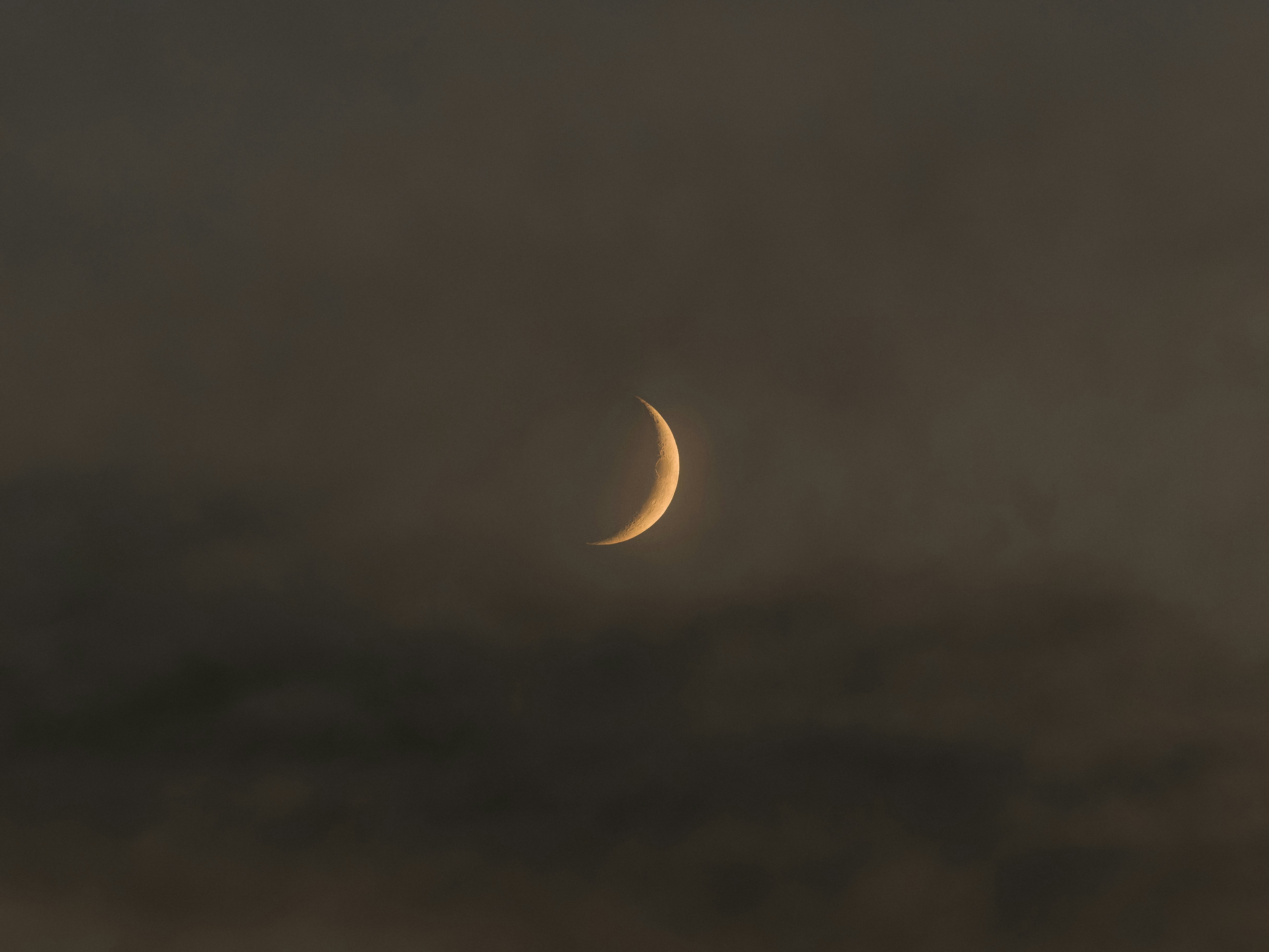 Crescent Quiet: Moonlit Veil Over Dusk Clouds