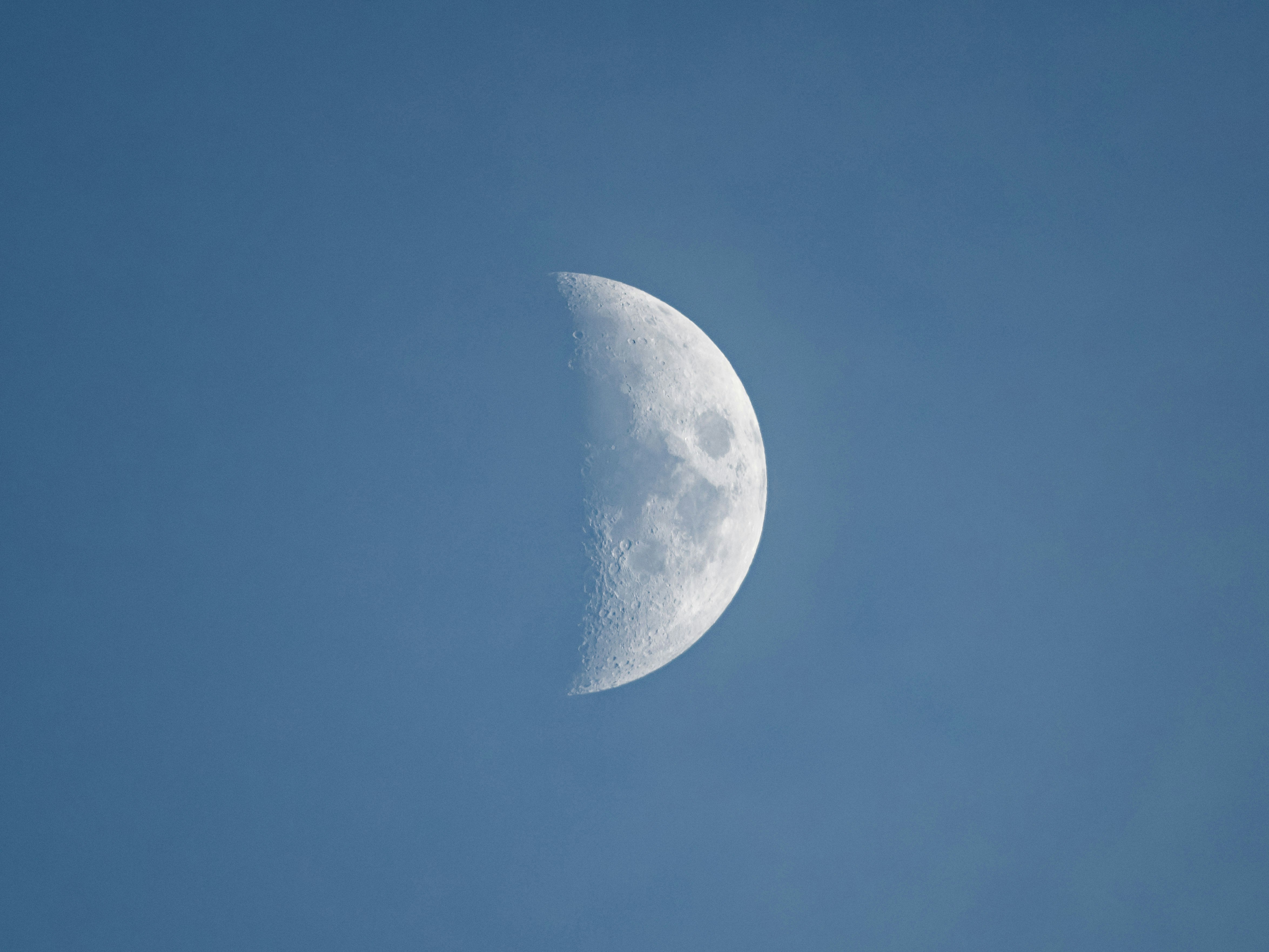 Lone Crescent: Moon in a Quiet Blue Sky