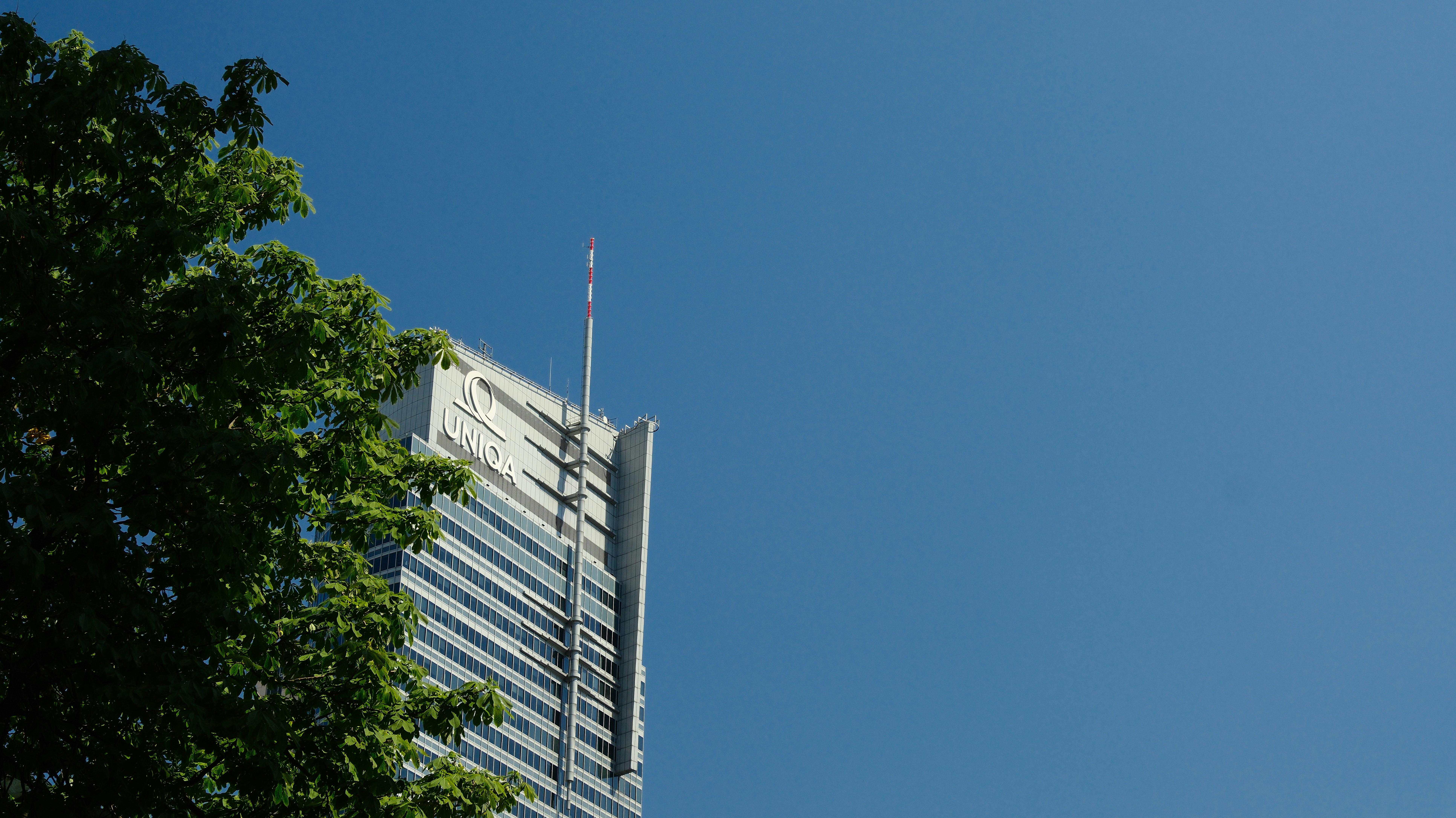 Cresting Sky: City Tower Reaches for Blue