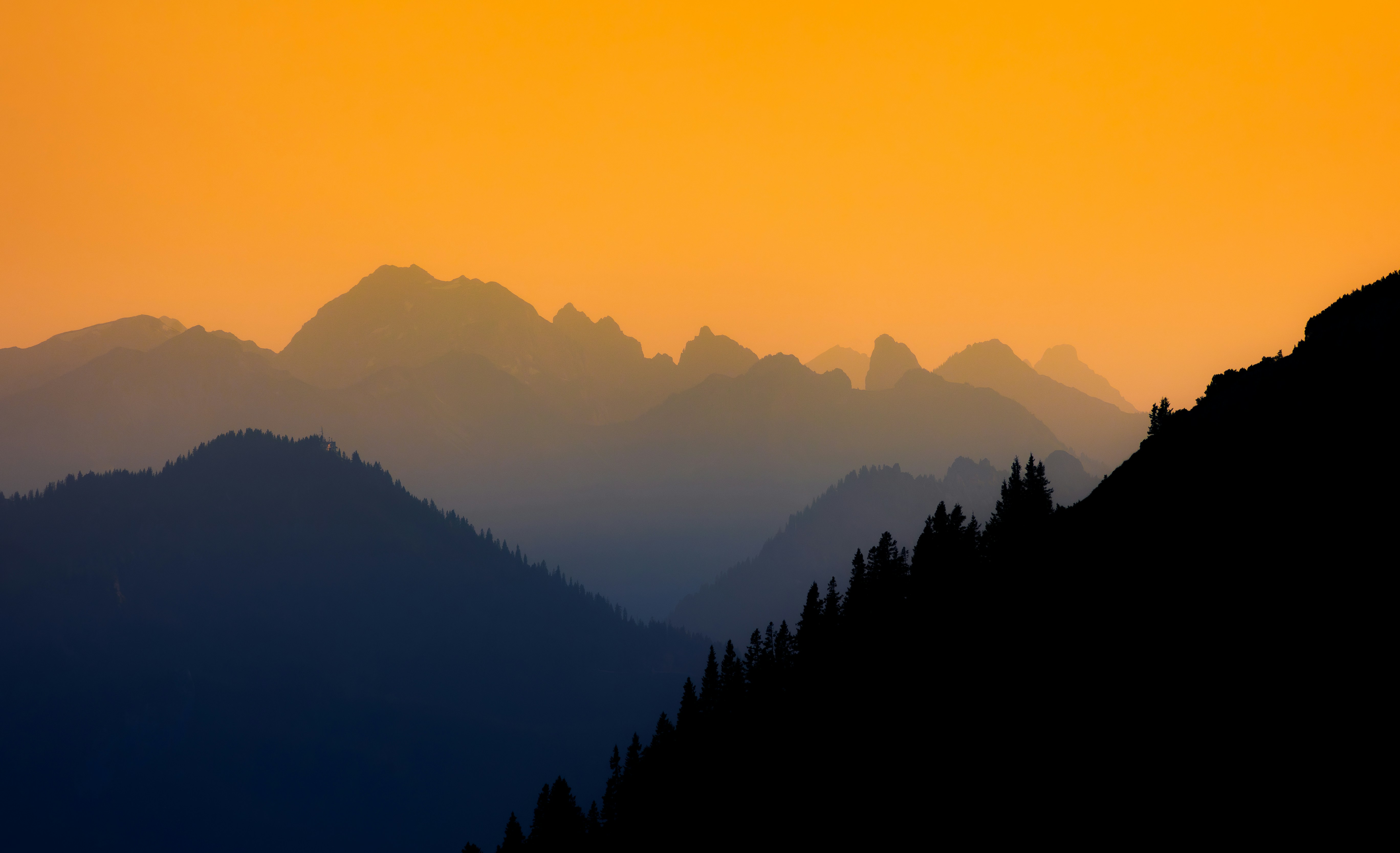 Golden Summit Silhouette Over Quiet Valleys