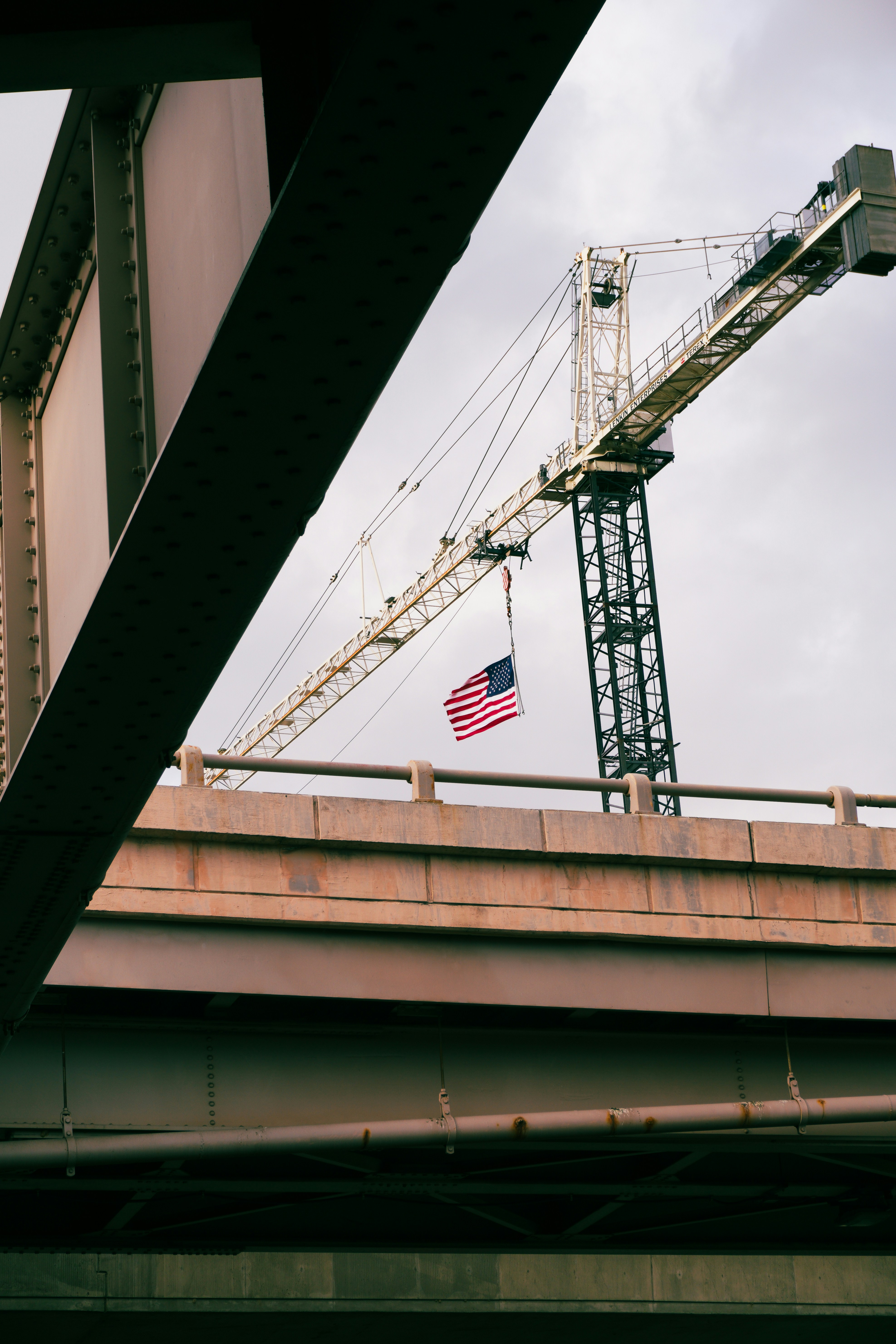 Crane Lines and Flag in the Urban Sky