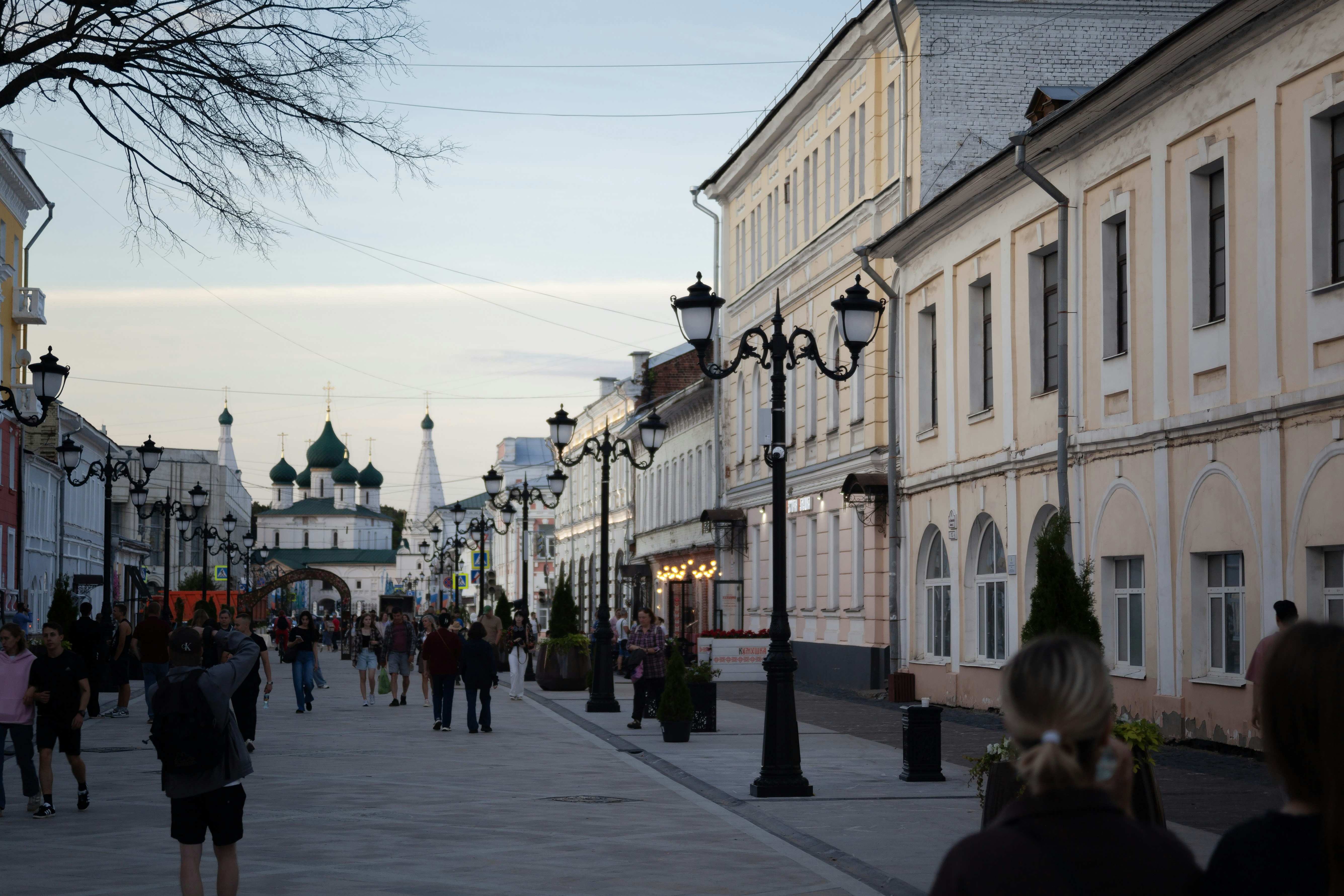 A Crowded Street Unfolds Toward a Green-Gilded Cathedral