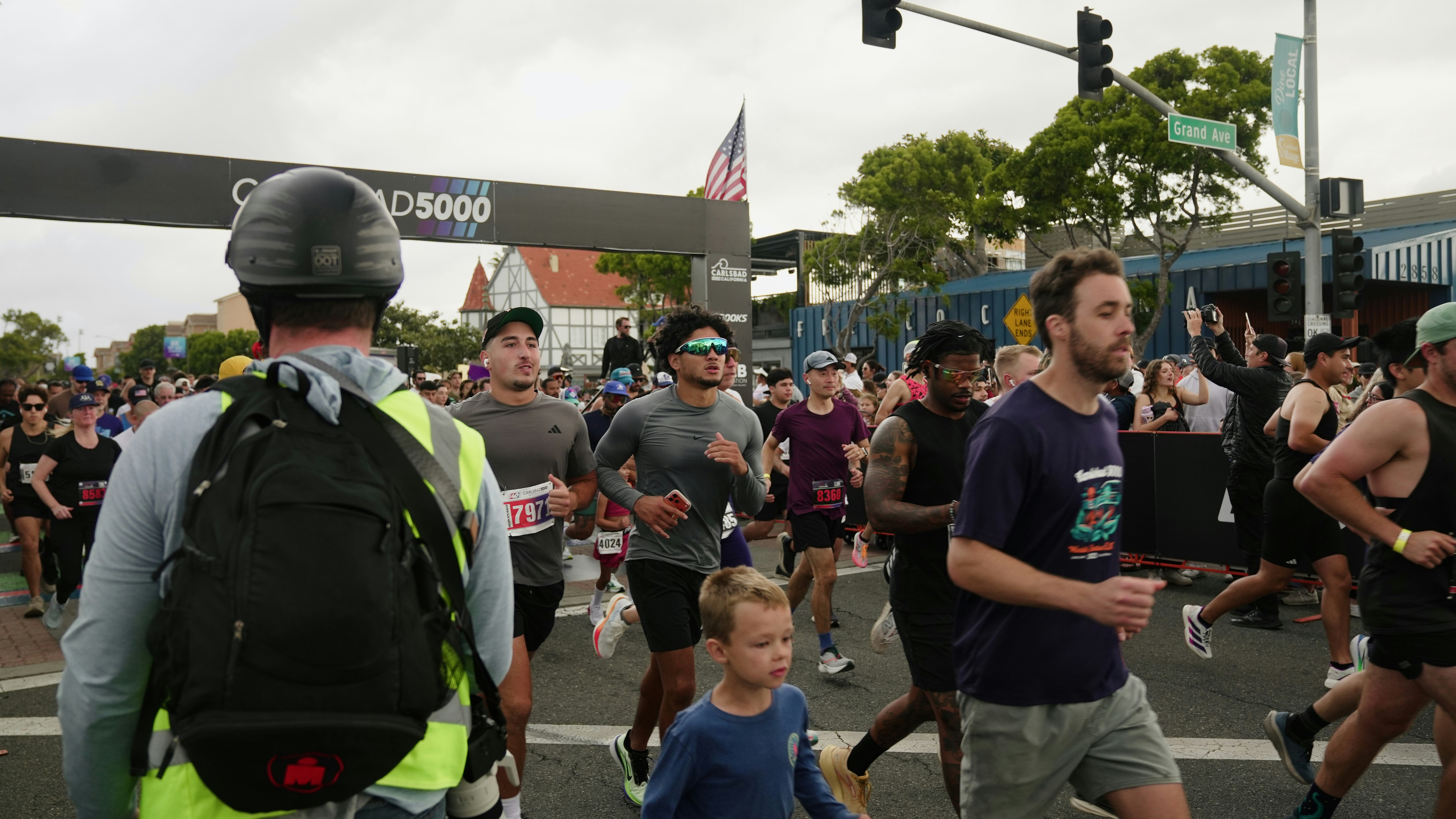 Starting Line Pursuit: A Crowd Surges Forward as Runners Push Toward the City