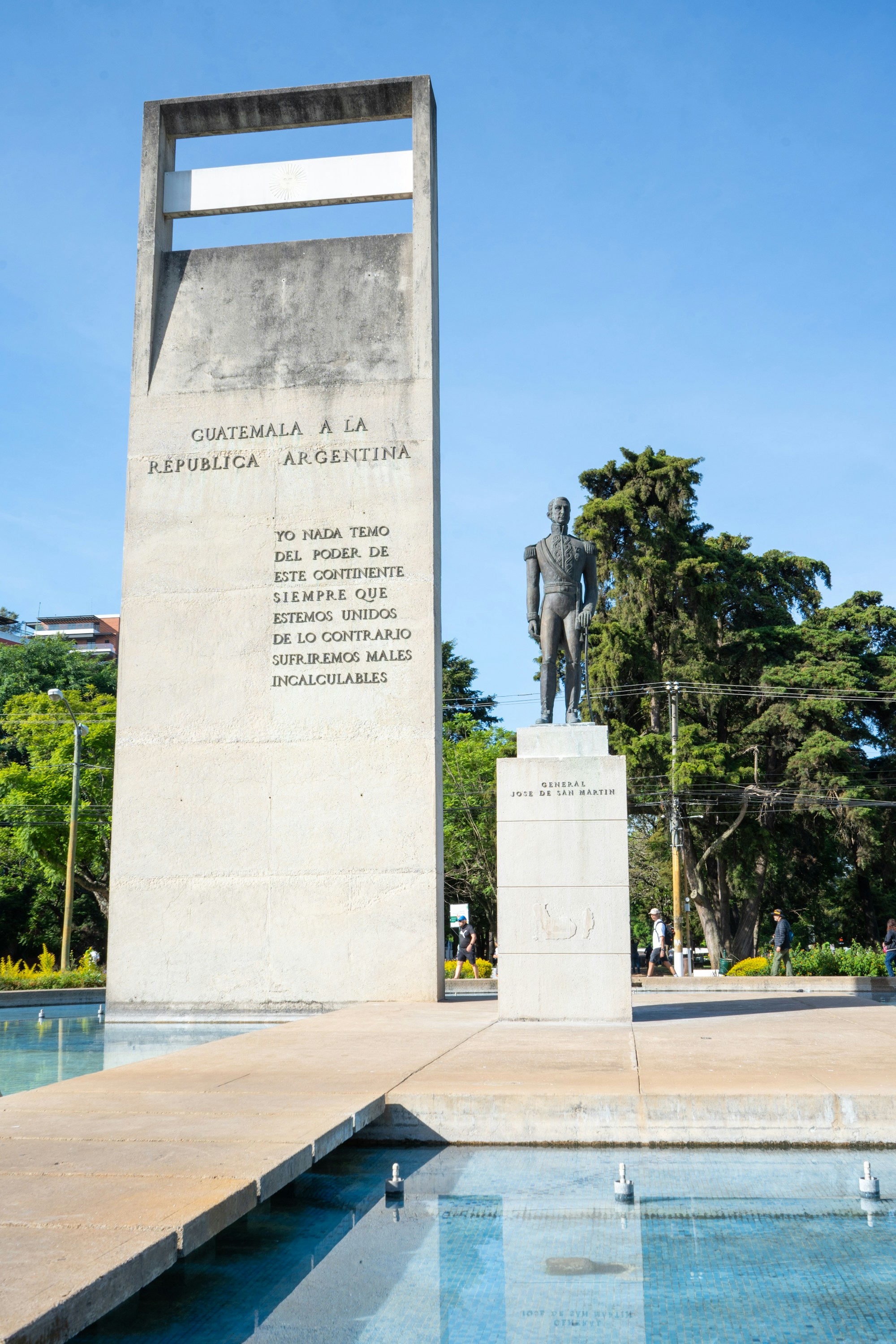 Monumental Pair: A Tall Obelisk and a Bronze Sentinel Framing a Quiet Park