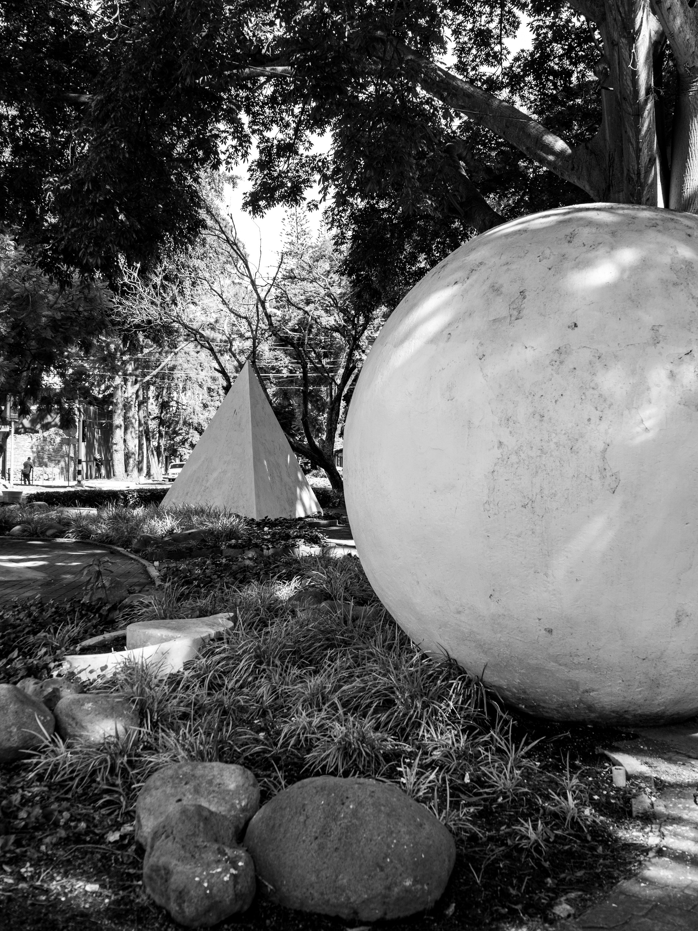Geometric Quiet: A Sphere and a Pyramid in Dappled Light