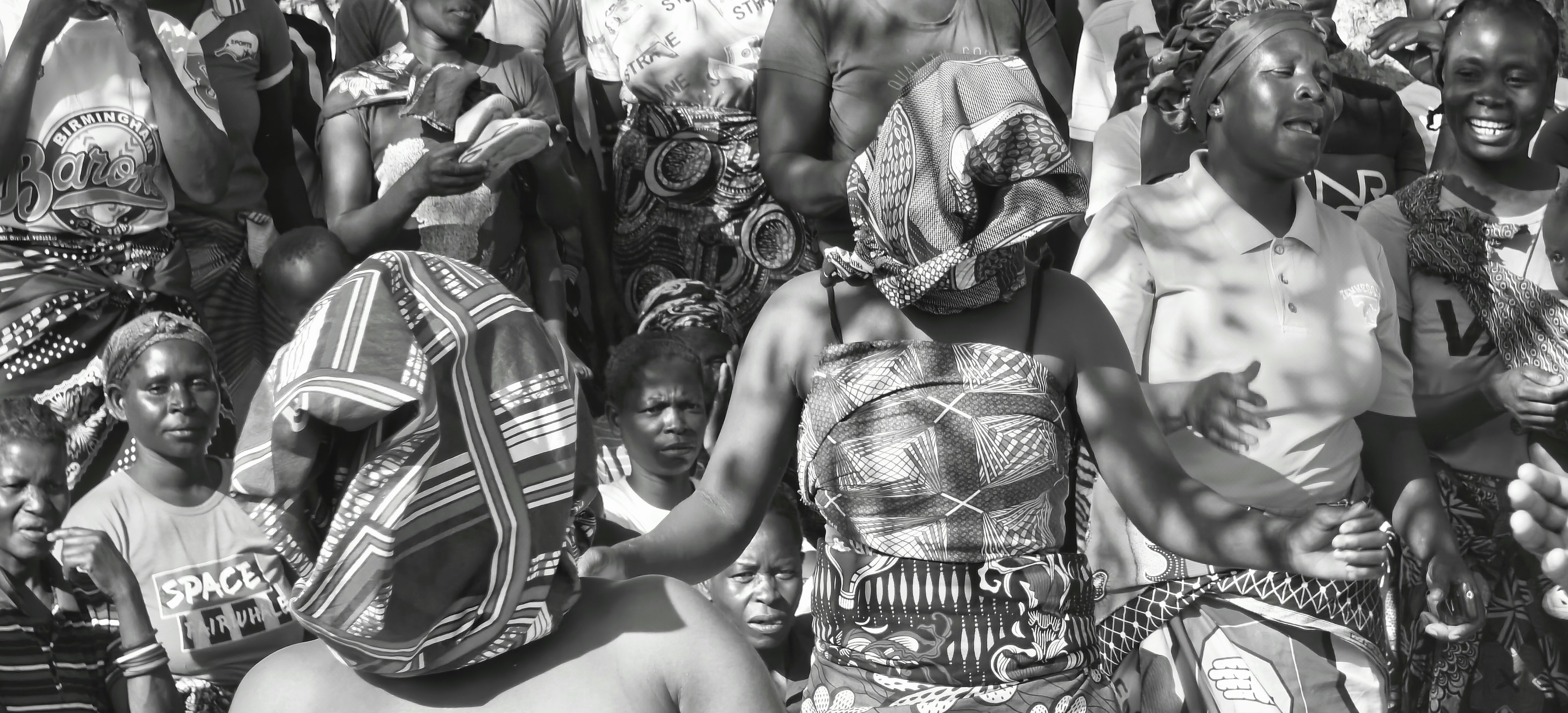 Crowd Harmony: Festive Attire and Shared Gaze in a Black-and-White Gathering