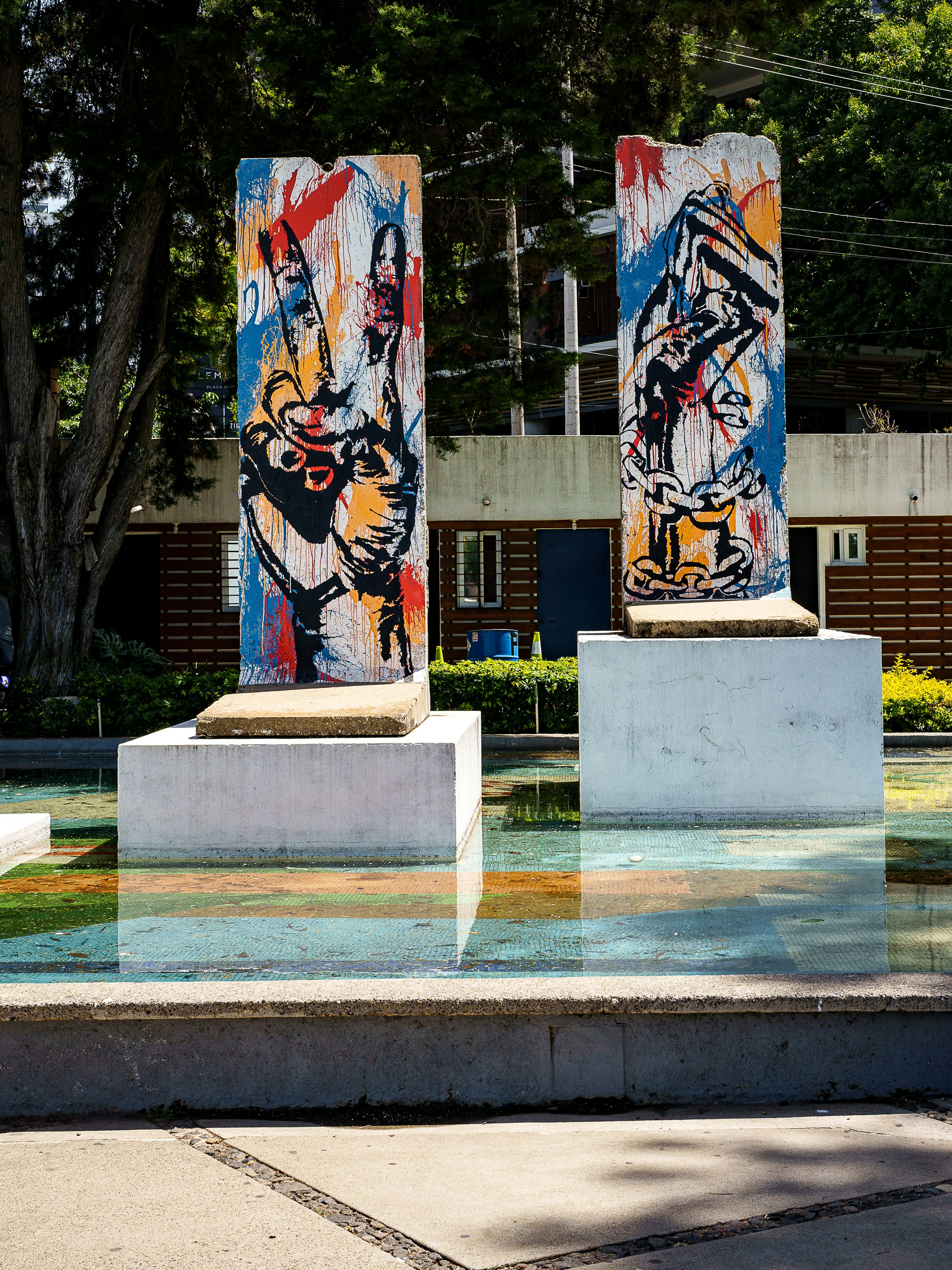 Graffiti Columns over Still Water: Urban Art Framed by Fountain