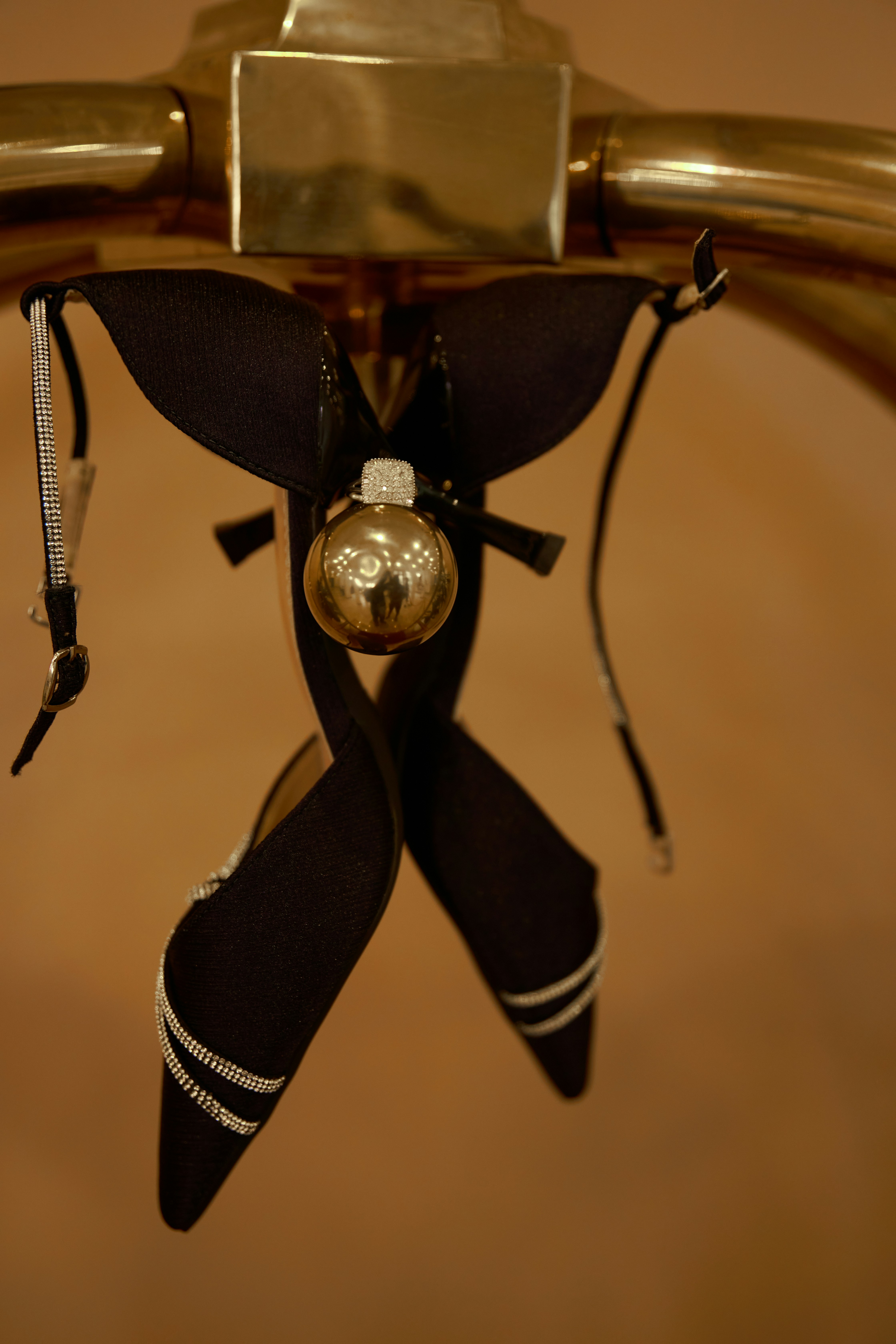 Underarm Satin: A Bow-Tedeased Ornament Hangs from Copper Rails
