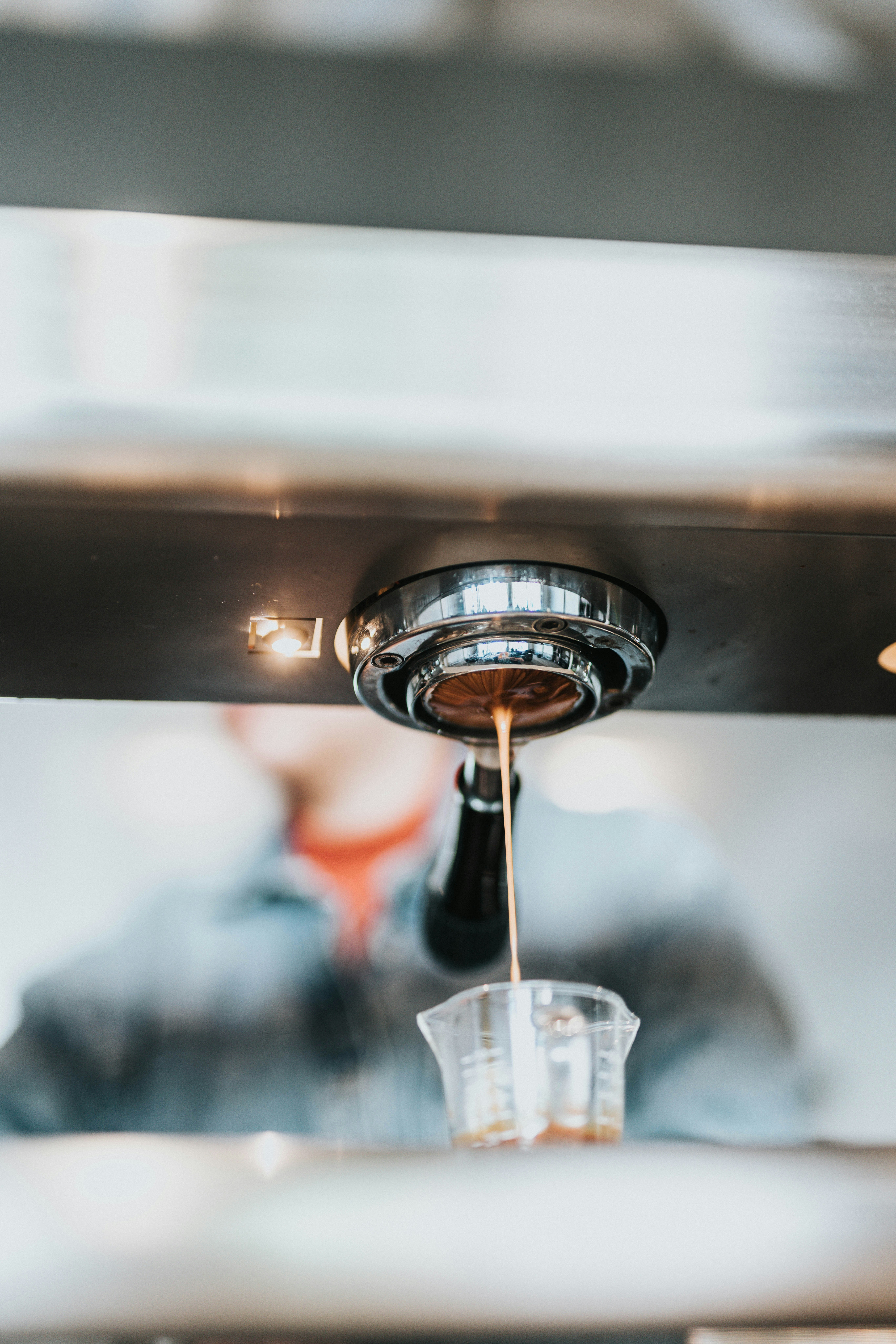 Liquid Rhythm: Espresso Flow Under Metal Ring
