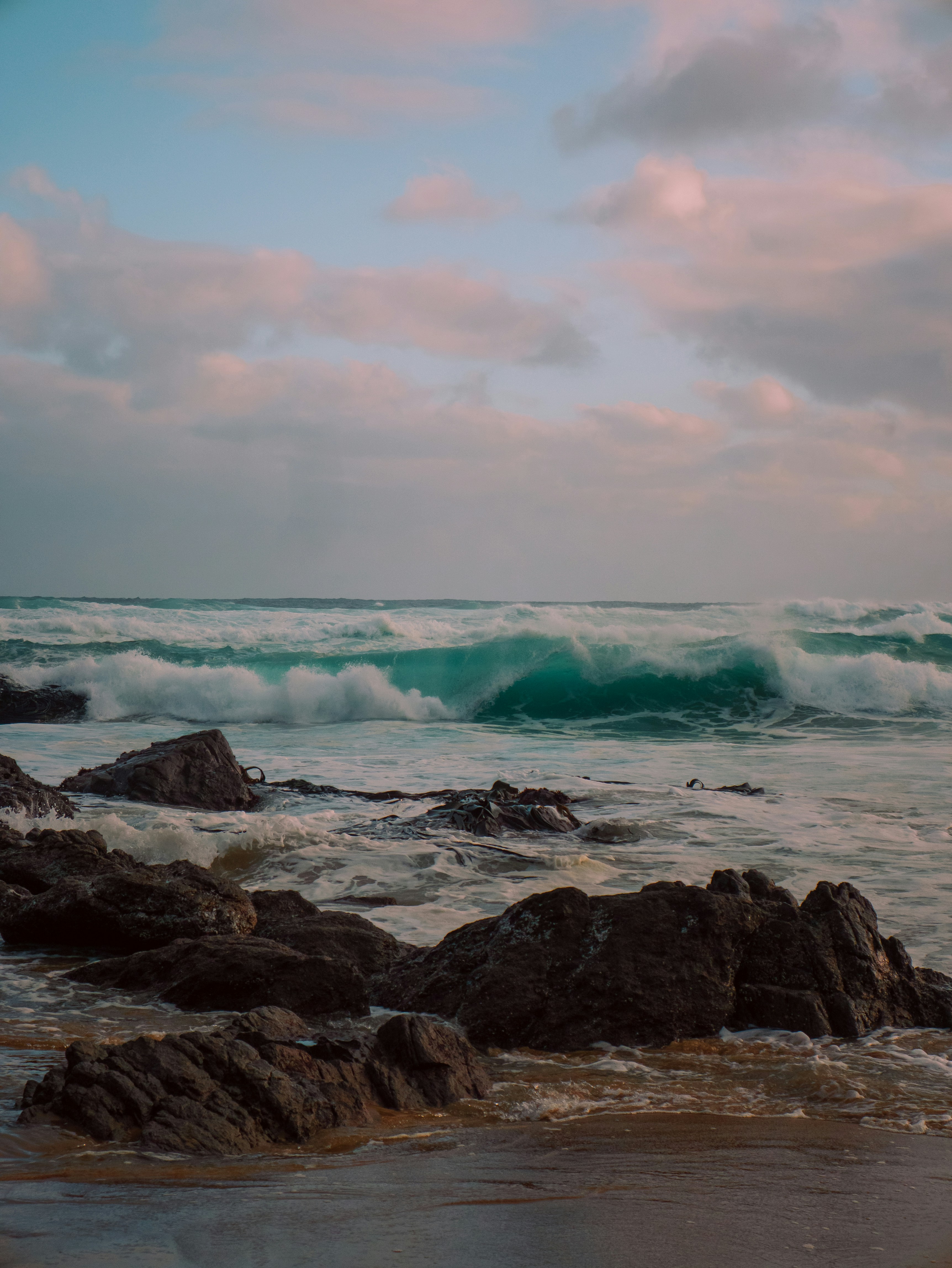 Tide’s Edge: Rugged Rocks Meet a Soft Sunrise Sea