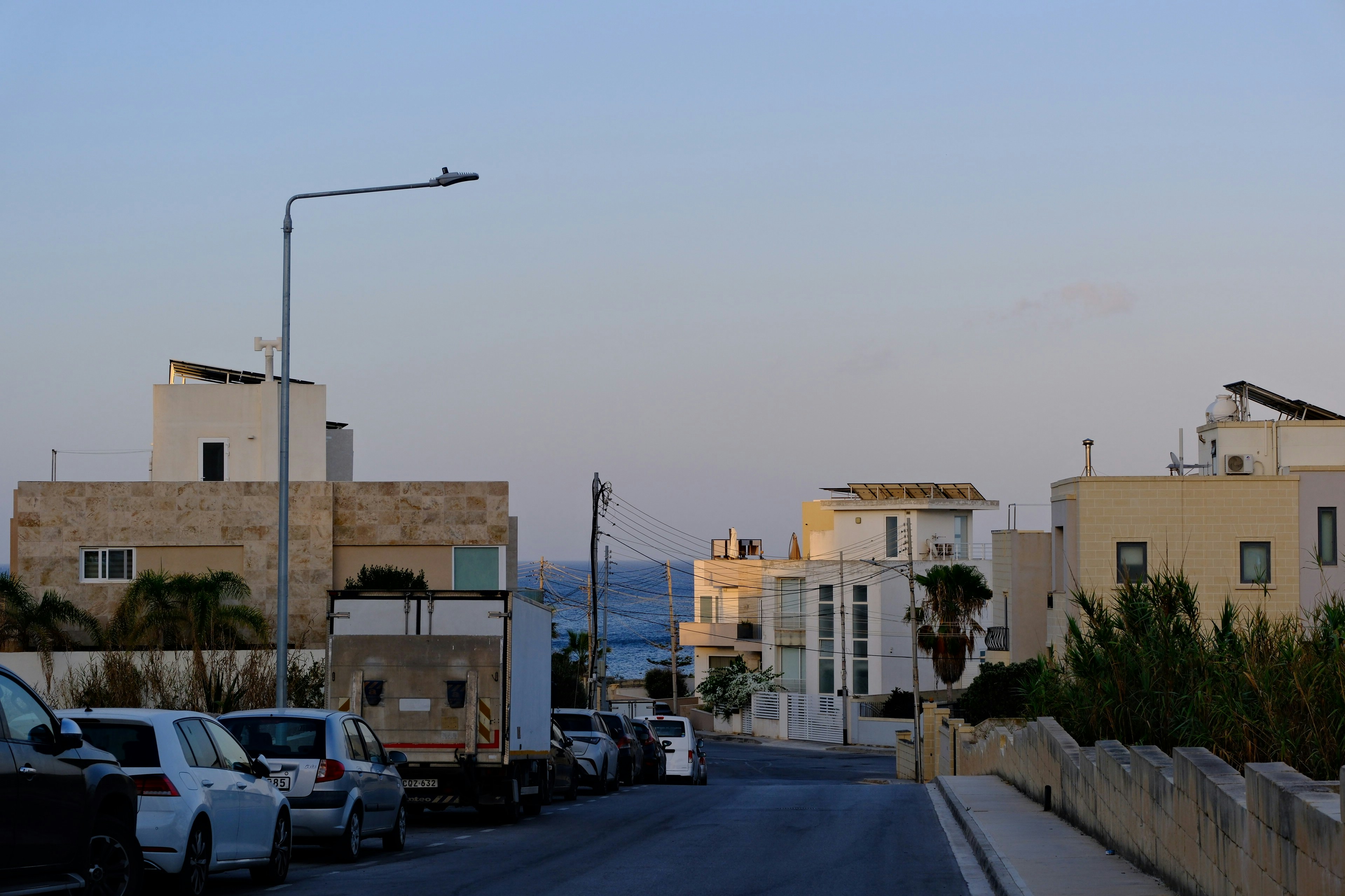 Coastal Avenue Beneath a Quiet Evening Sky