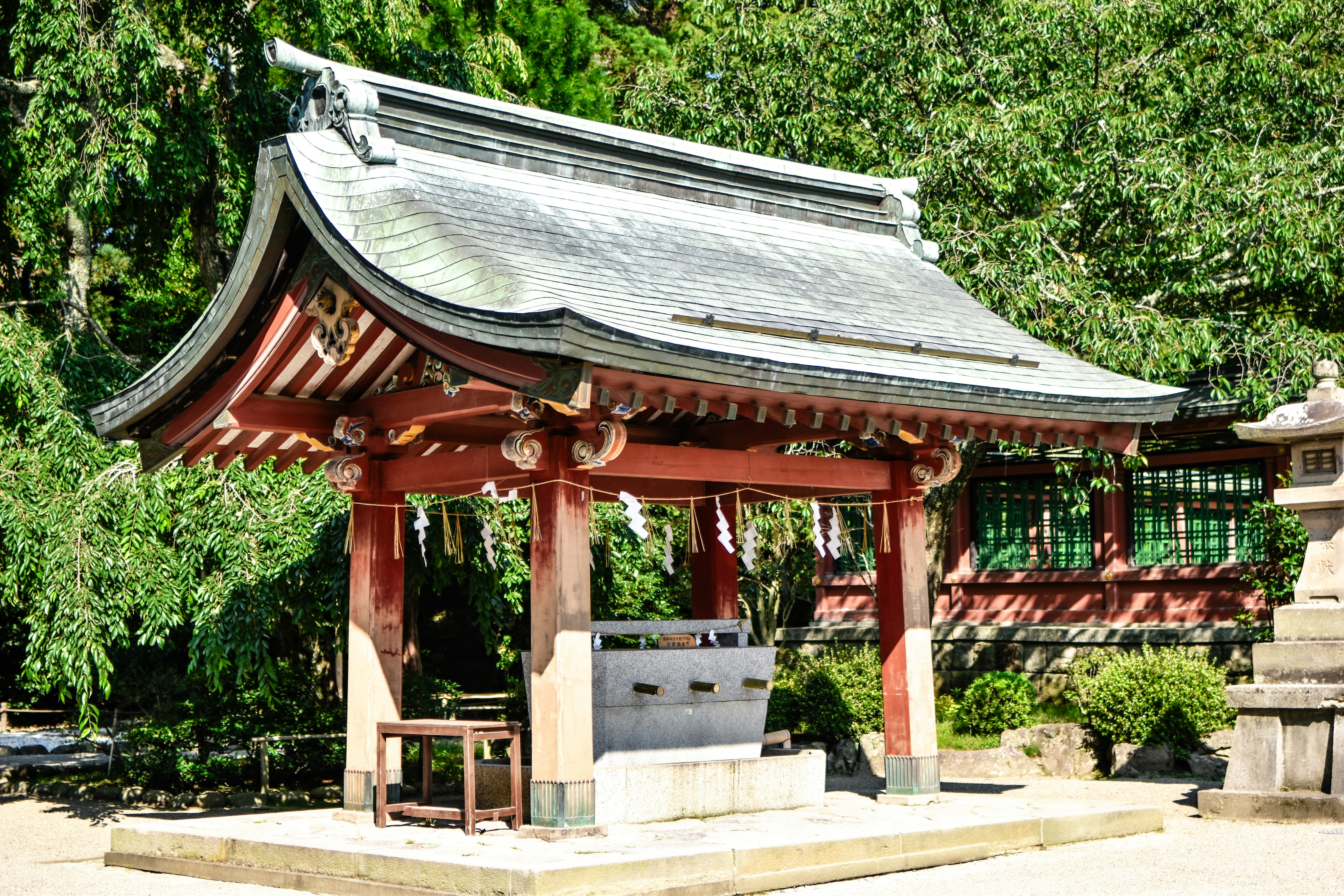Temple Gate in Quiet Courtyard: Evening Light on Cedar Roof and Stone Lantern
