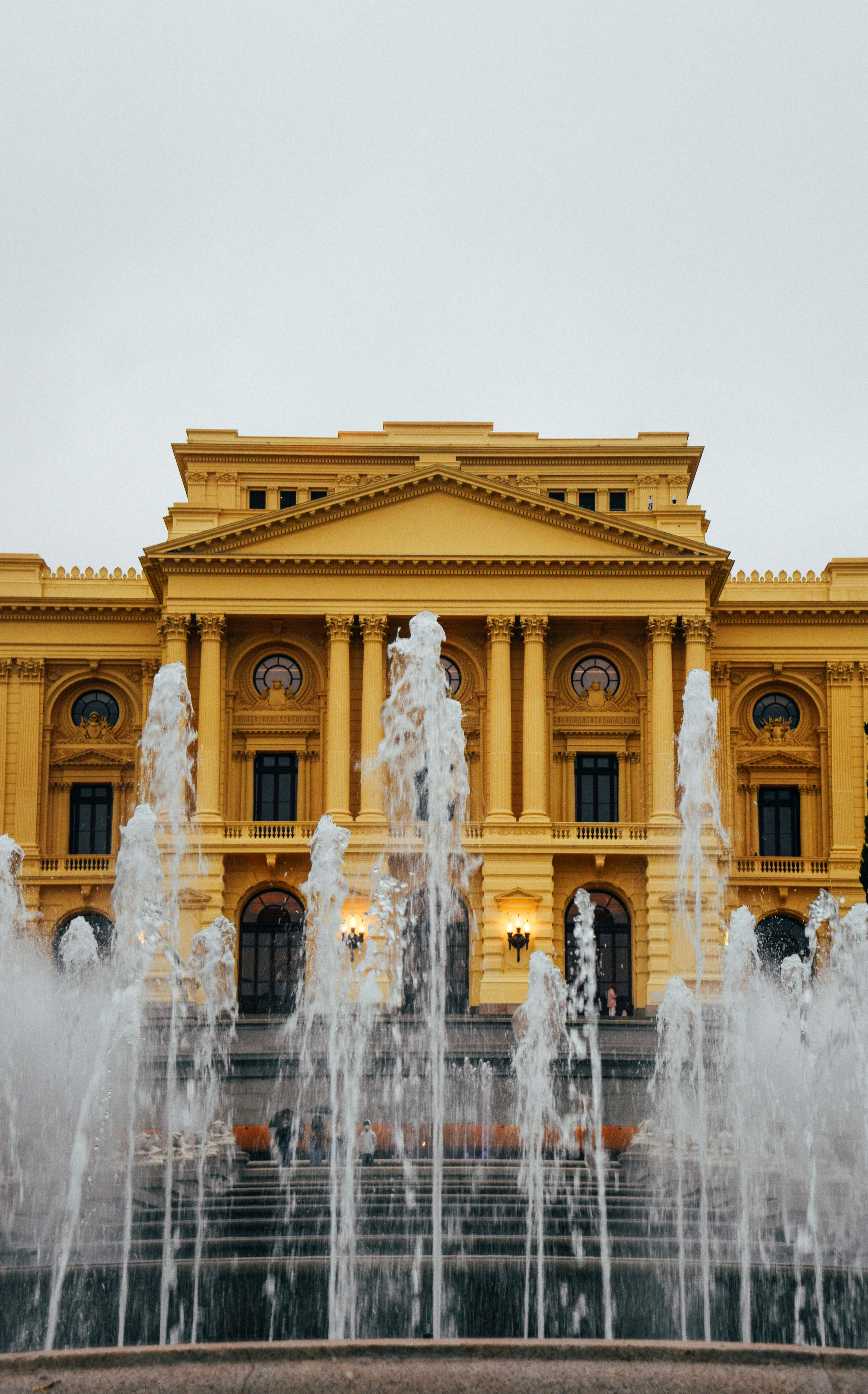 Golden Facade Awakens: Fountains before a monumental neoclassical building