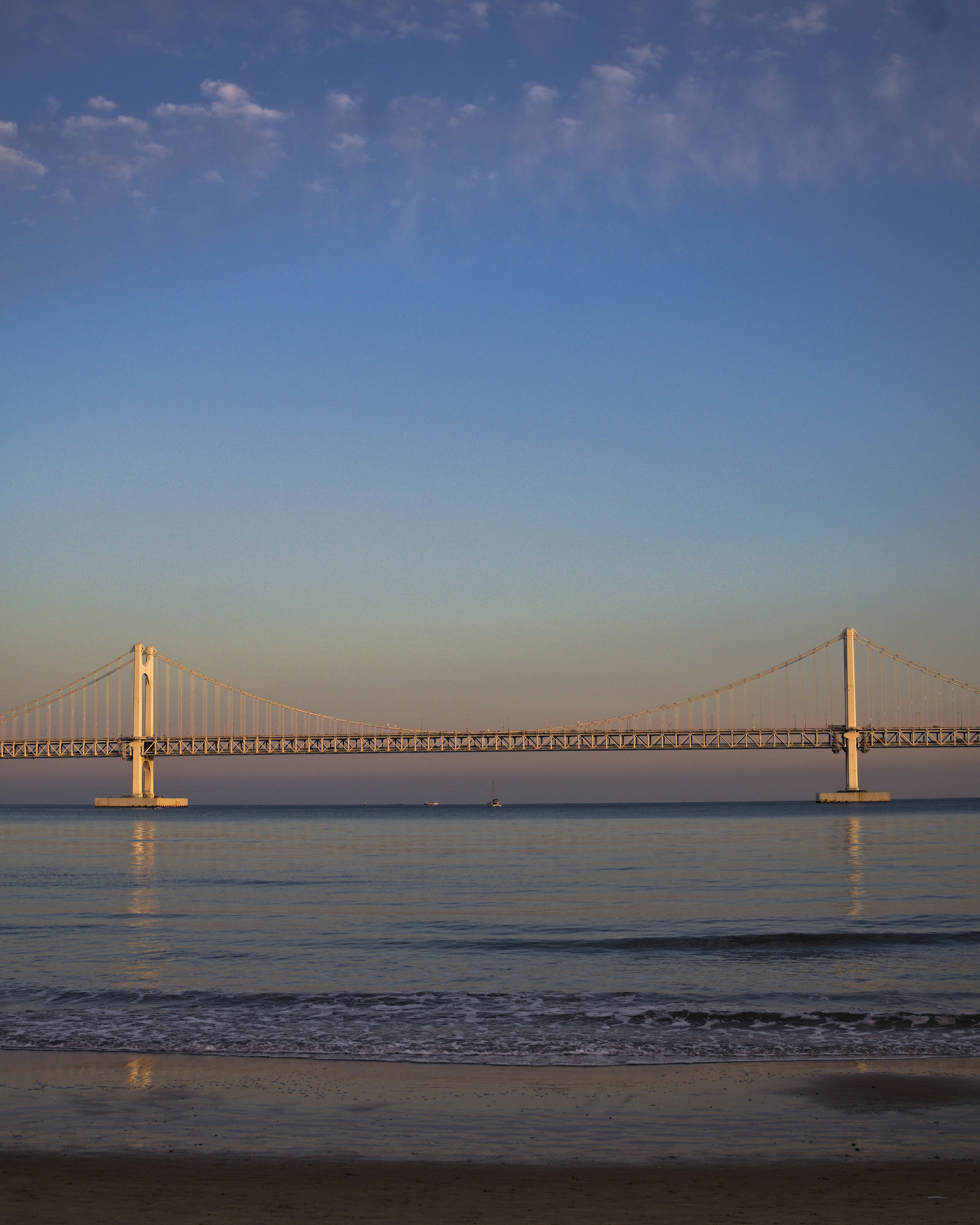 Bridge over Calm Seas at Sunset
