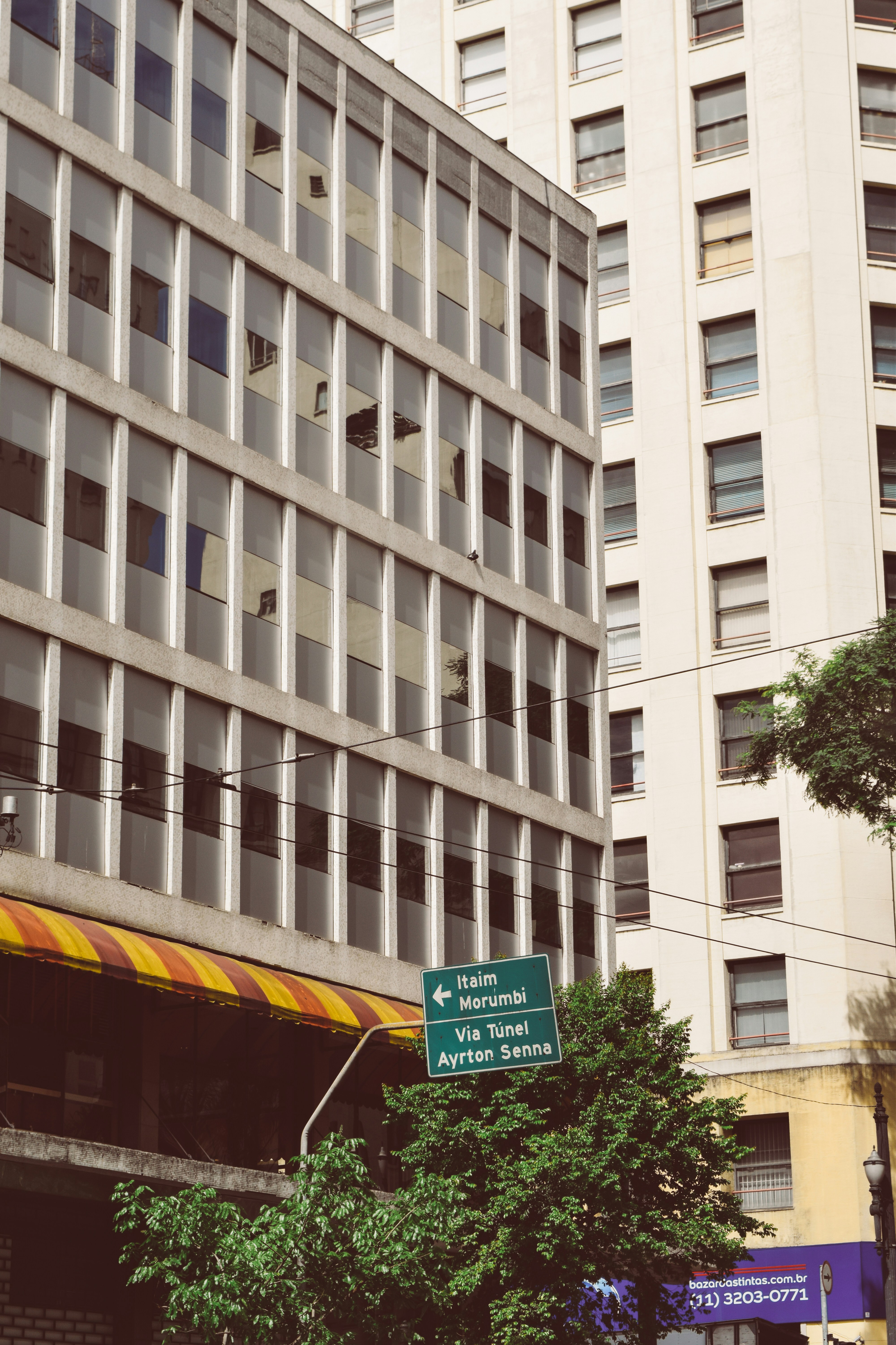 Diverging Facades: Urban Grid and Awned Street Sign