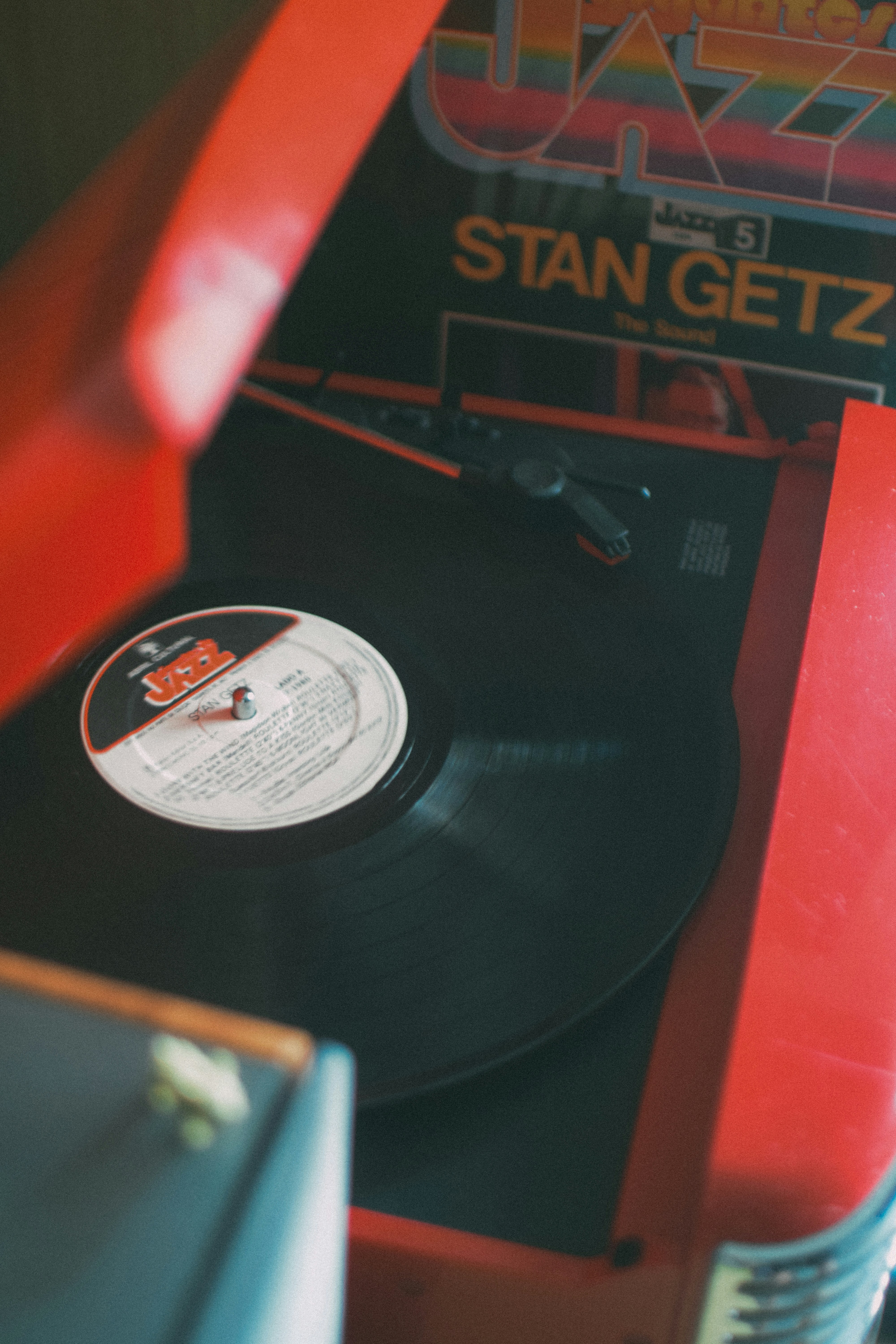 Spin of nostalgia: a vinyl tucked within a retro arcade cabinet glow