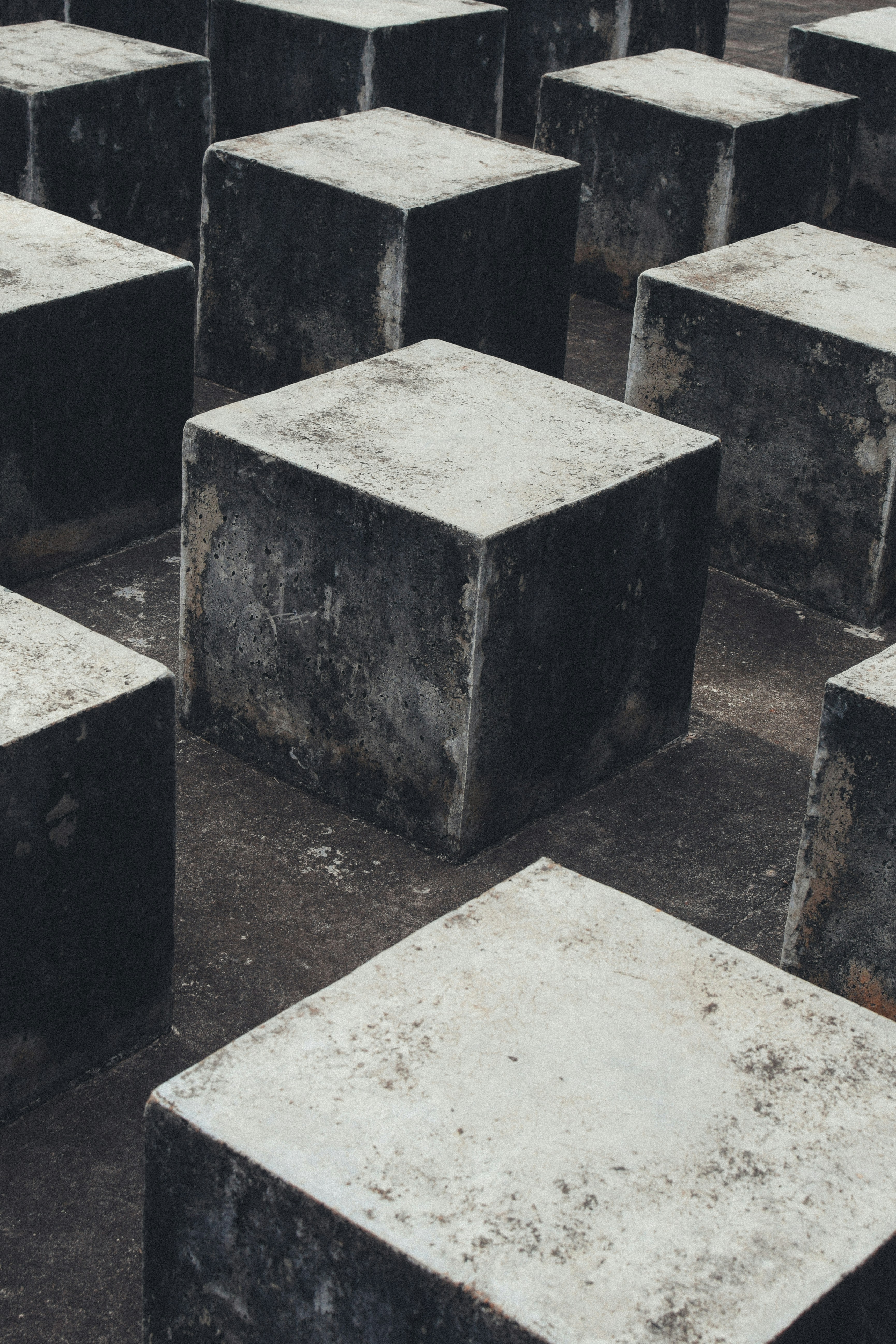 Monumental Grid: Weathered Cubes Rising from the Ground