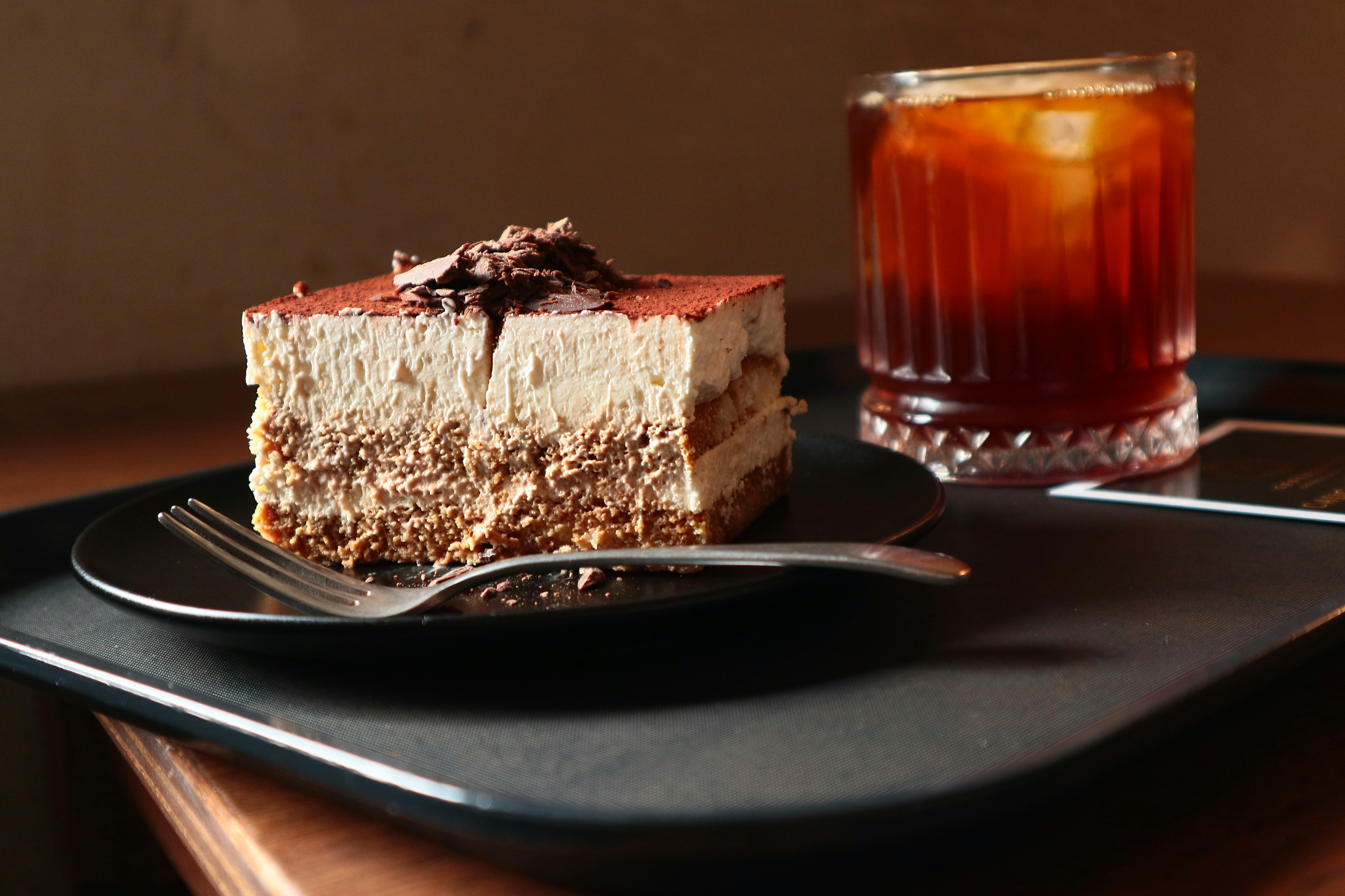 Slice of Chocolate Mousse with a Fading Amber Old Fashioned
