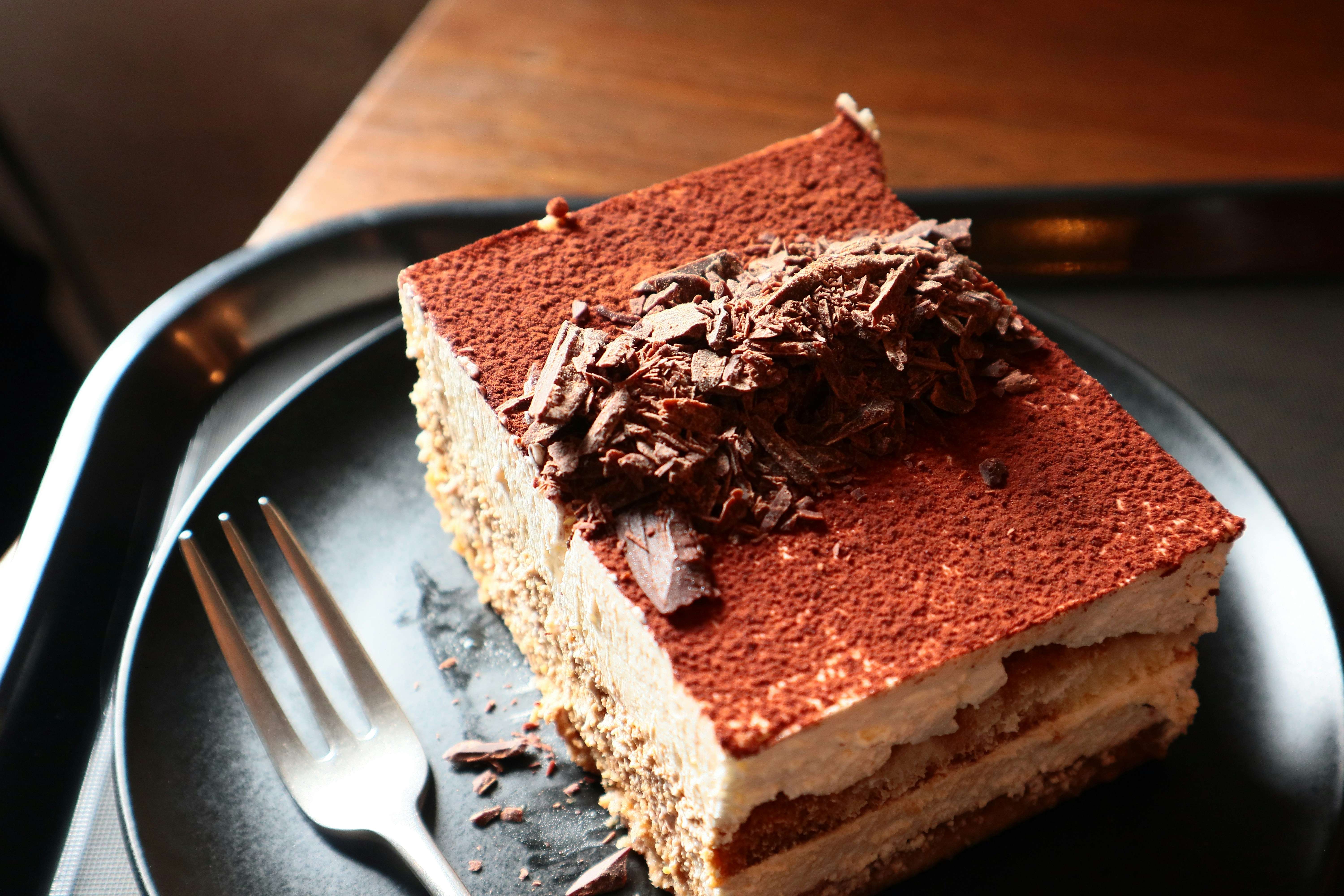 Decadent Chocolate Tiramisu Slice Nestled on a Dark Plate