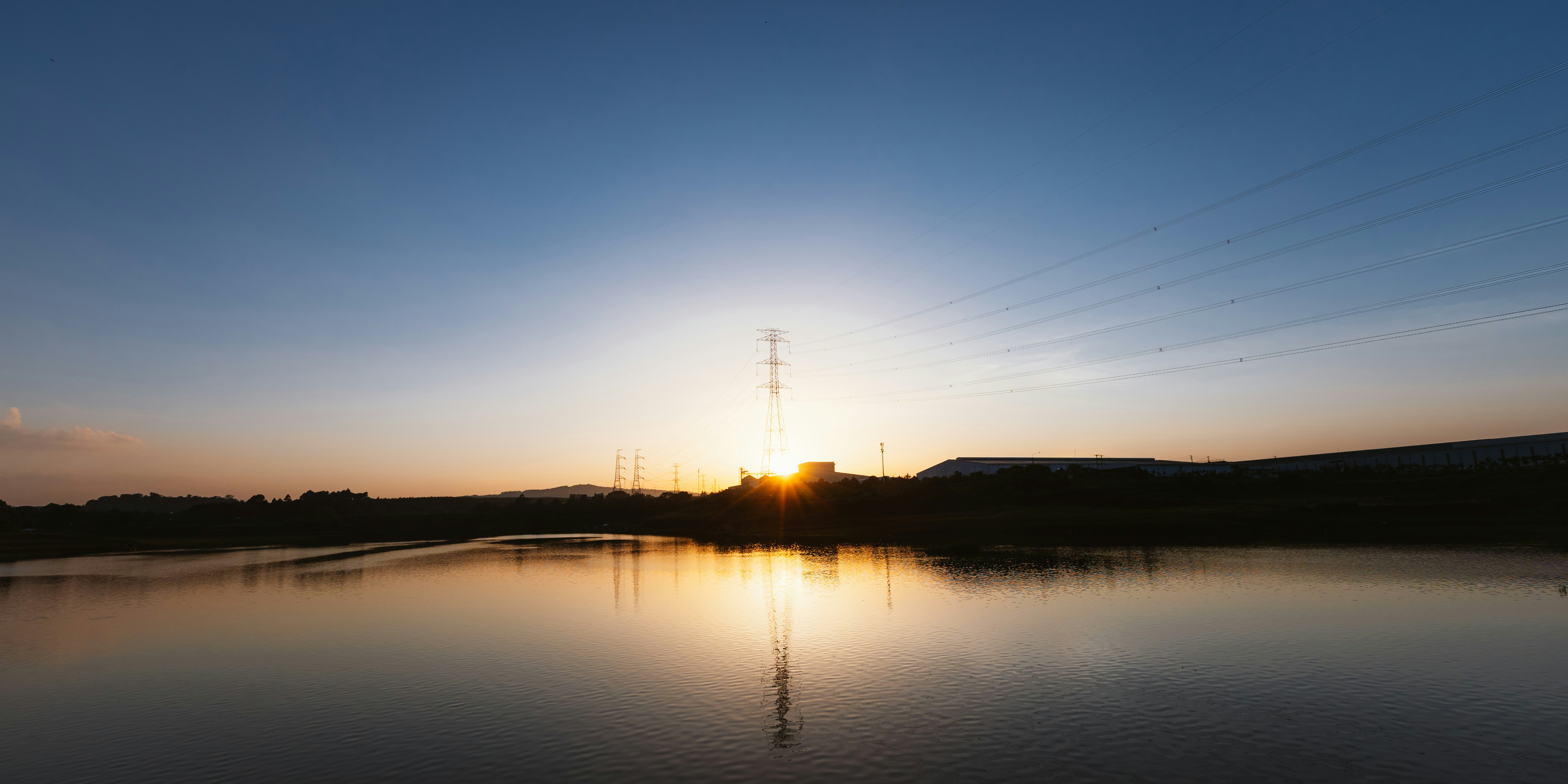 Dawn Over the Quiet Water: Silhouettes and Reflection