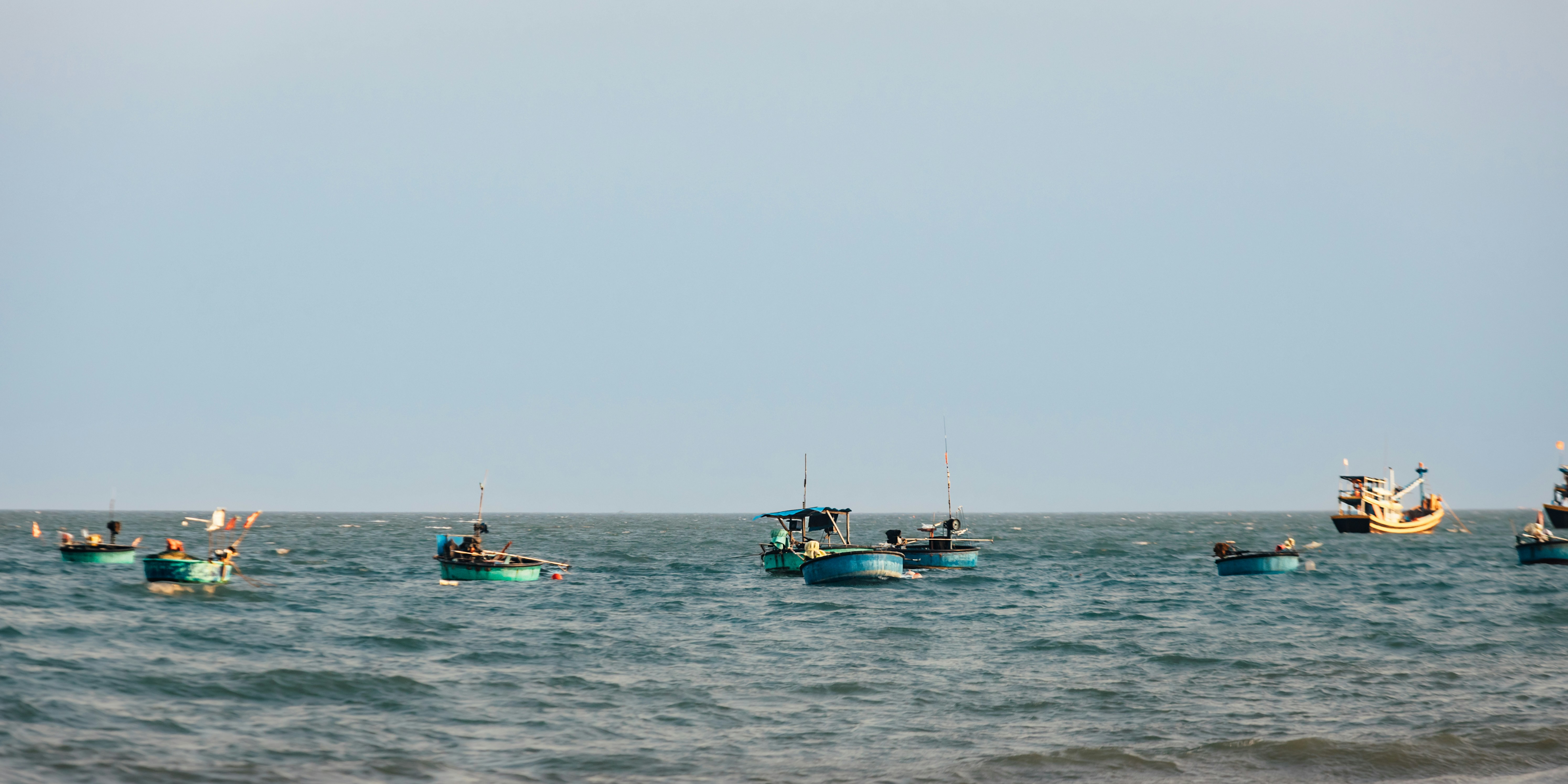 A Row of Small Boats on a Calm Sea