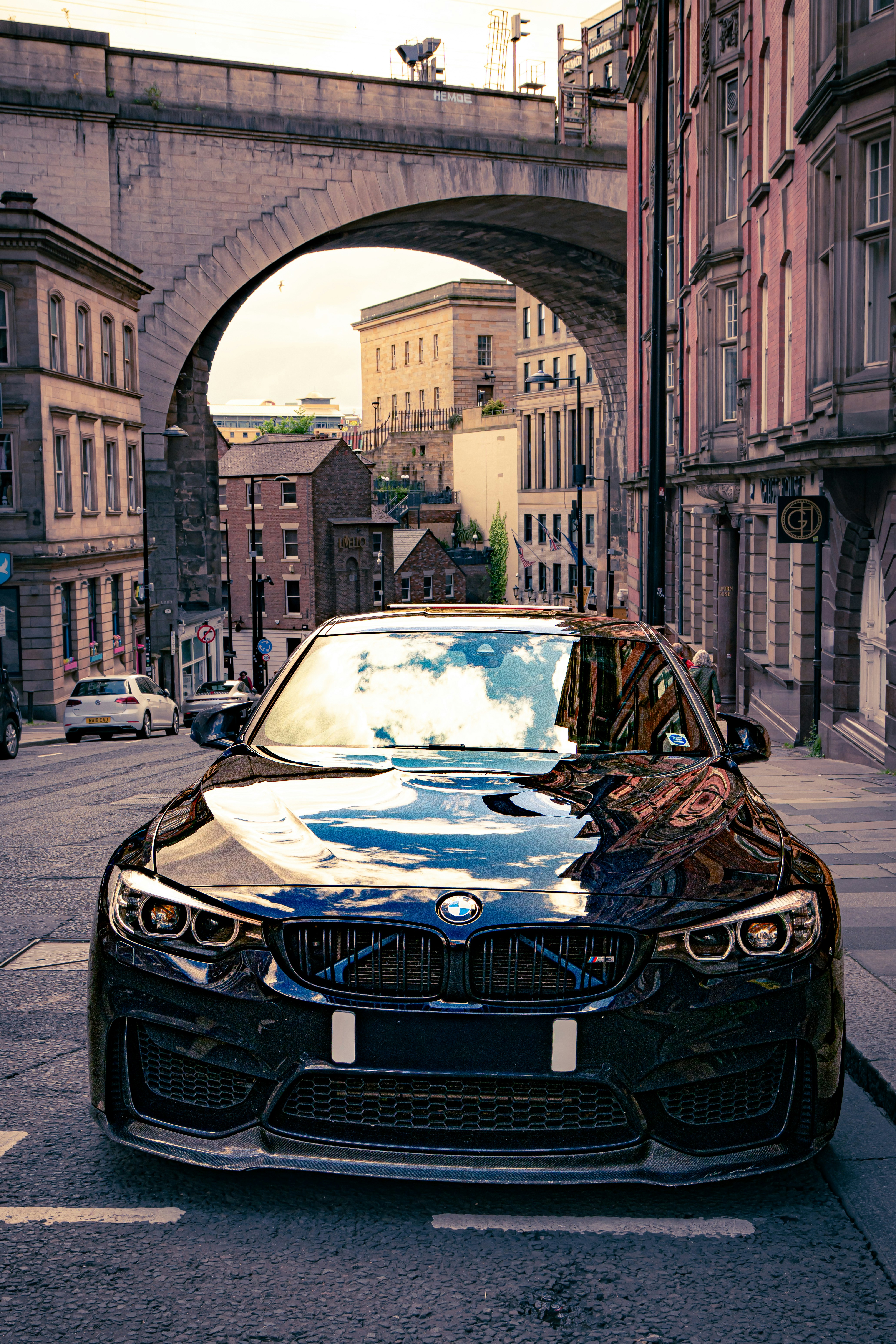 Sleek Street Sentinel: A Midnight-Blue BMW Graces the Urban Arch