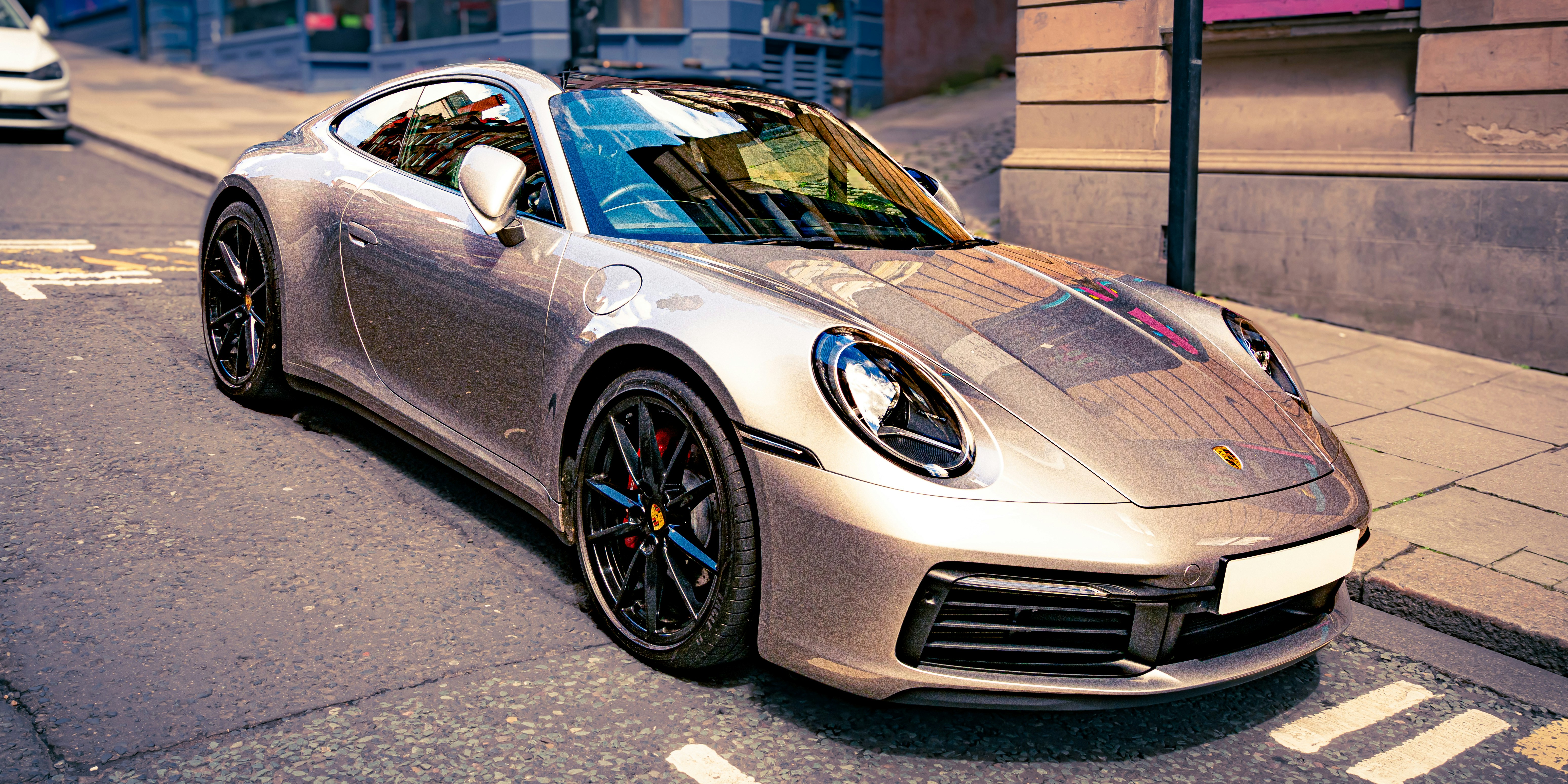Silver Porsche Panache: Street-Ready Steel and Glass on a Quiet City Corner