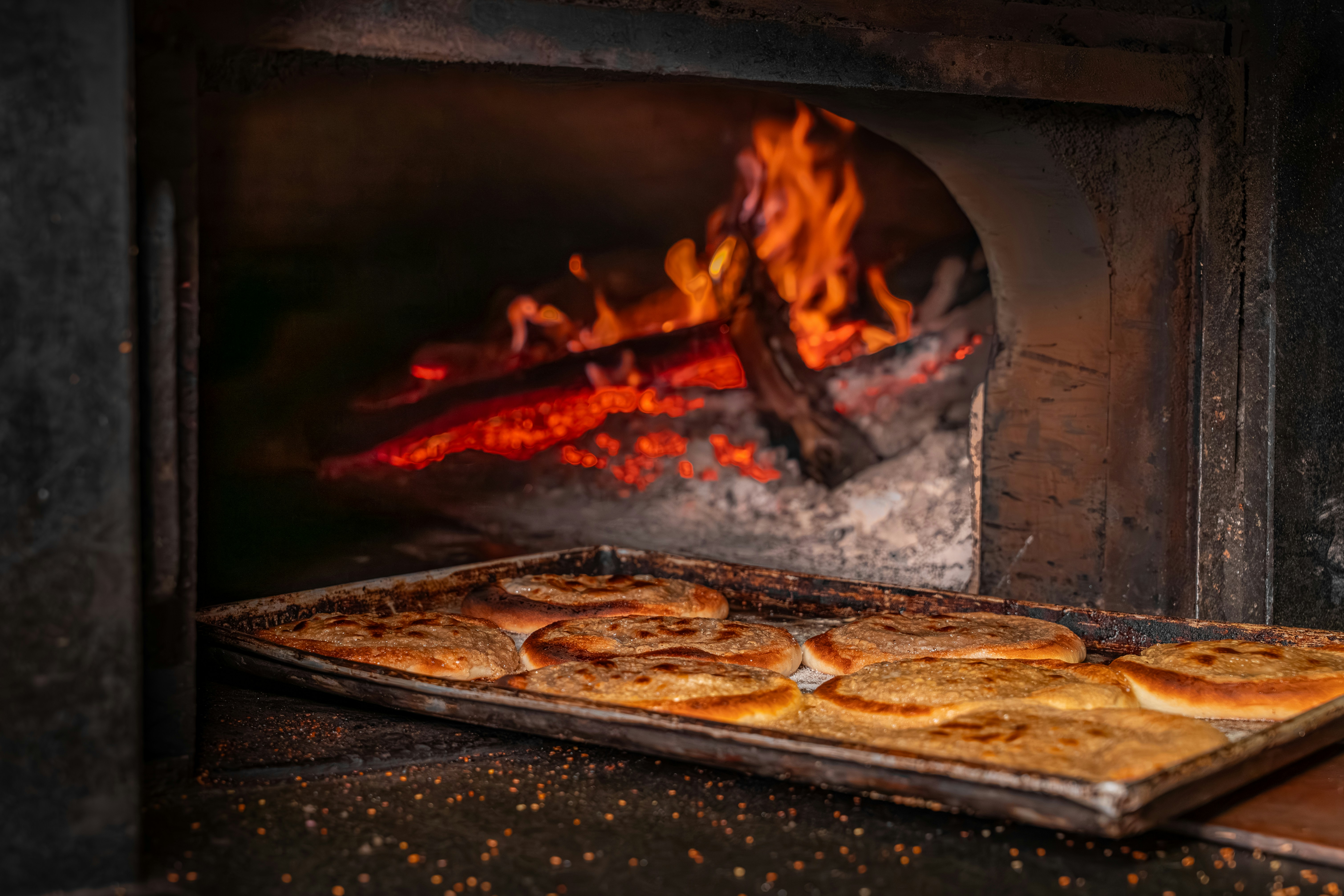 Tray of Golden Buns Baked to a Glowing Finish in a Wood-Fired Oven